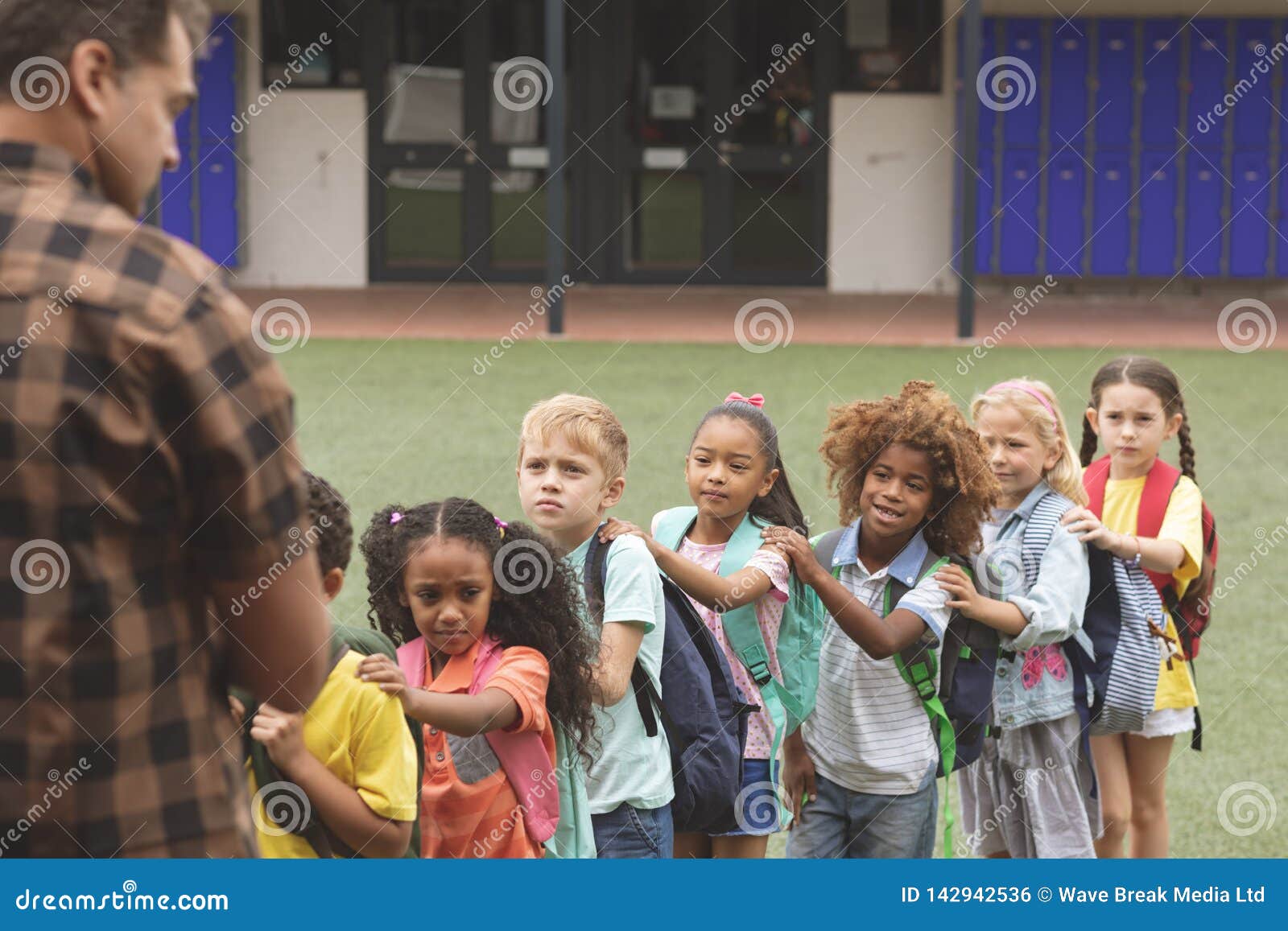 School Kids Standing in a Queue in the Schoolyard Stock Photo - Image ...