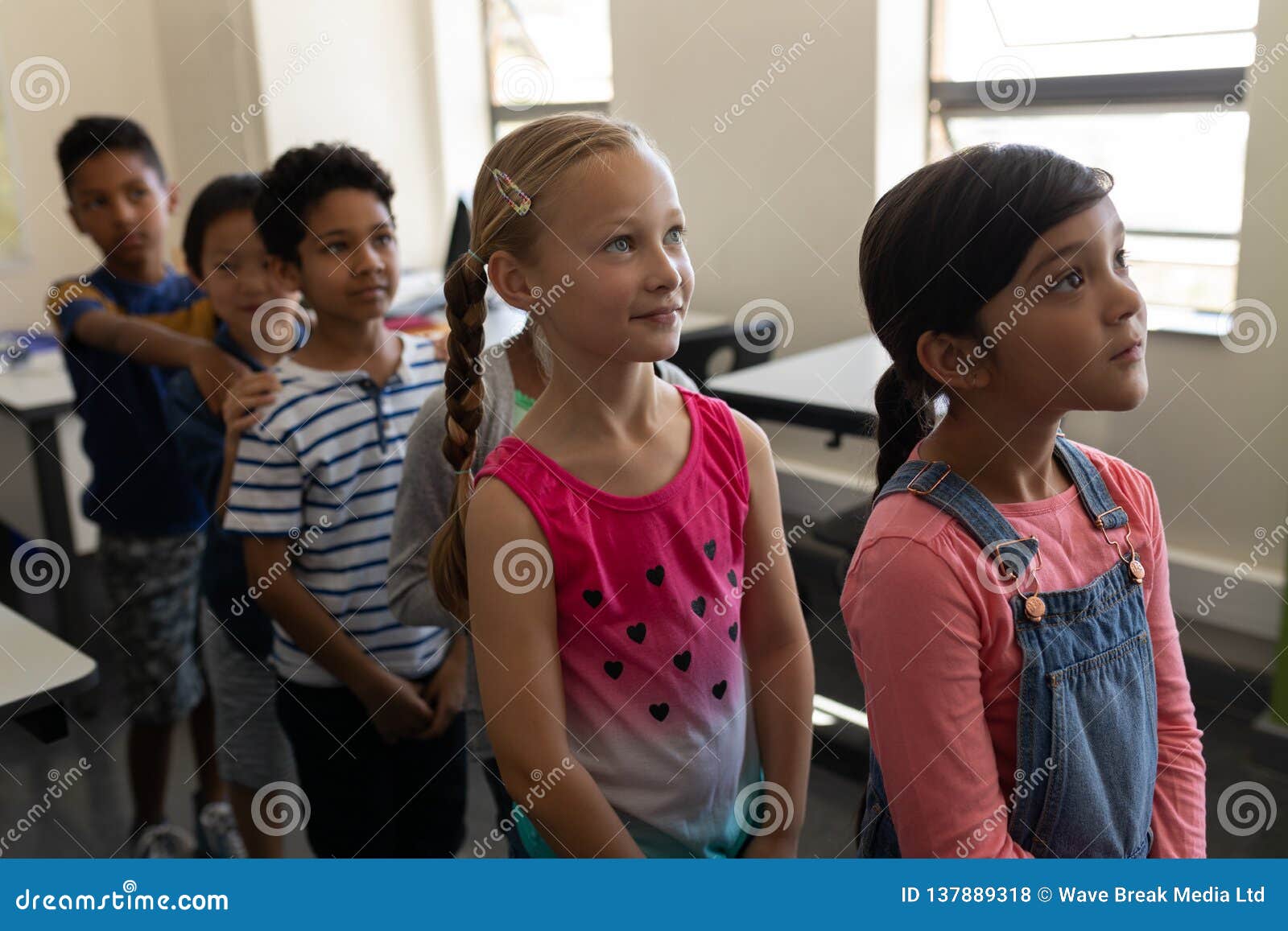 School Kids Standing in Row in Classroom of Elementary School Stock ...