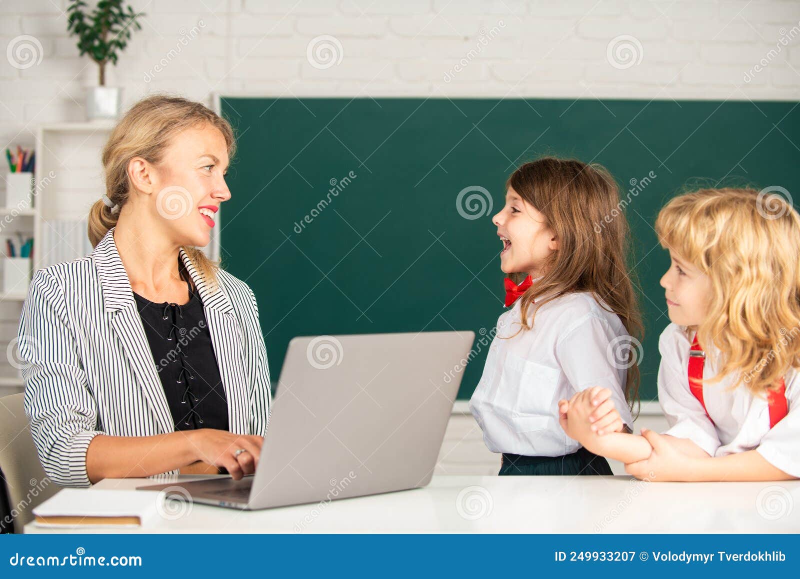 School Kids and Teacher Learning Study in Class. Teacher Helping Child ...
