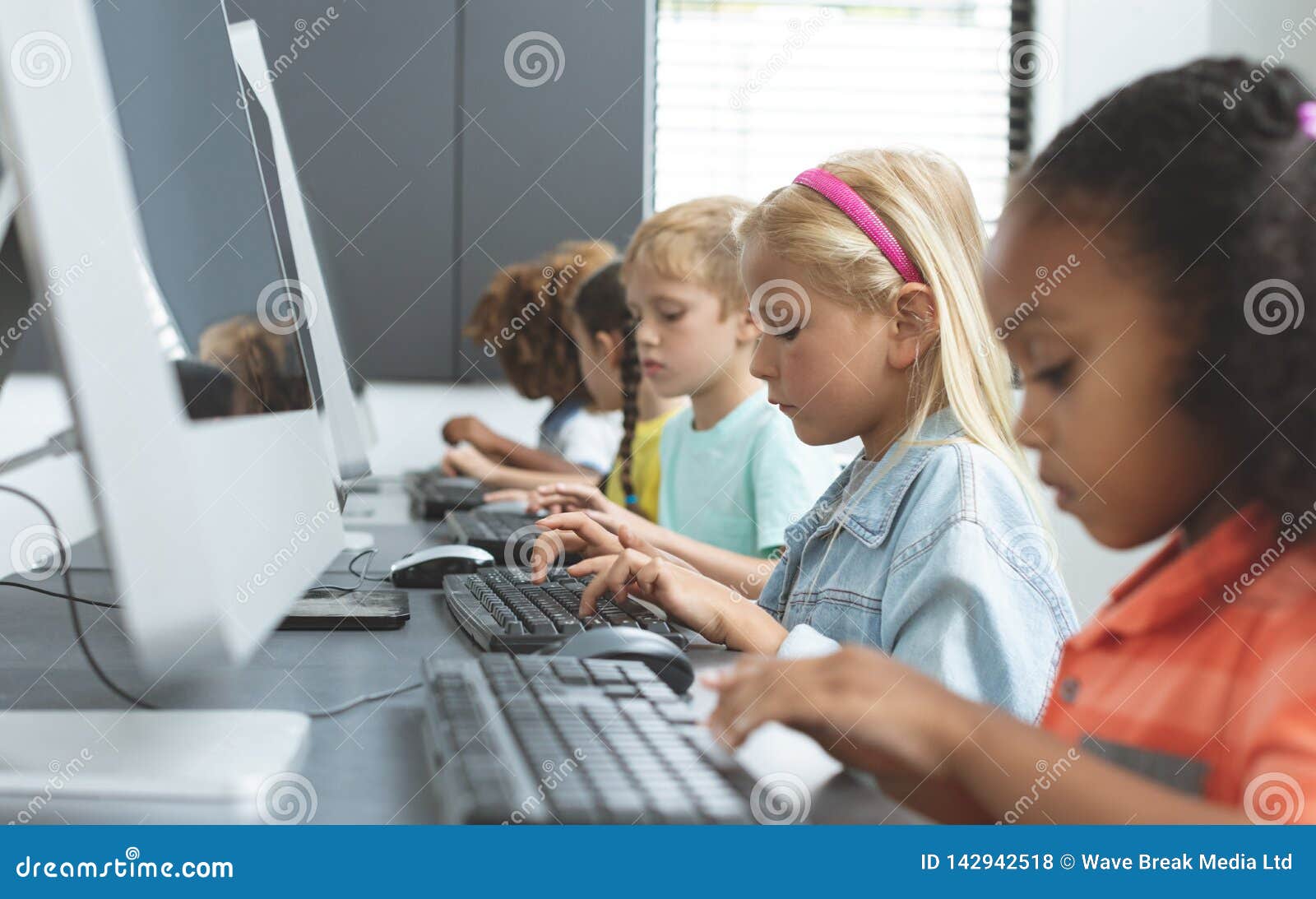 School Kids Using Computer in School Stock Photo - Image of focused ...