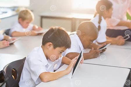 School Kids Using Digital Tablet in Classroom Stock Photo - Image of ...