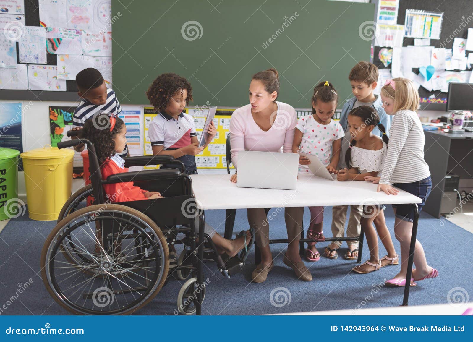 School Kids Using Digital Tablet while Teacher Interacting with ...