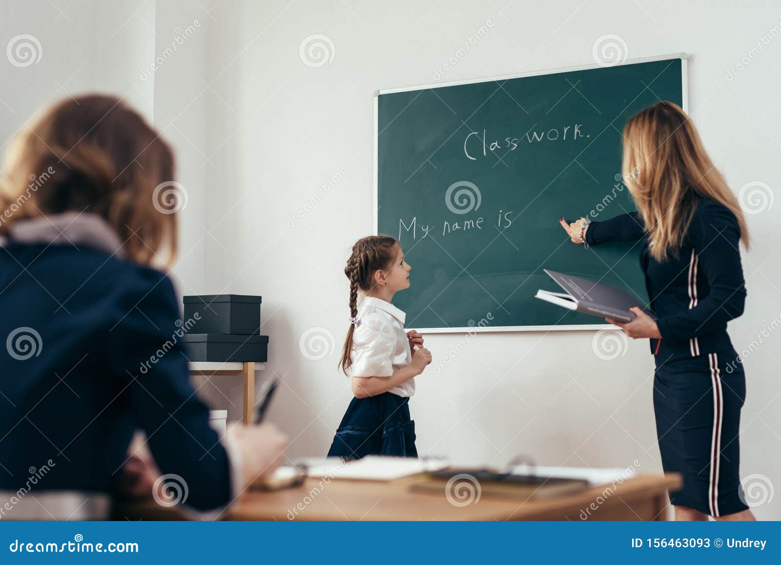 School Lesson Teacher and Pupil Write on a Blackboard Stock Image ...