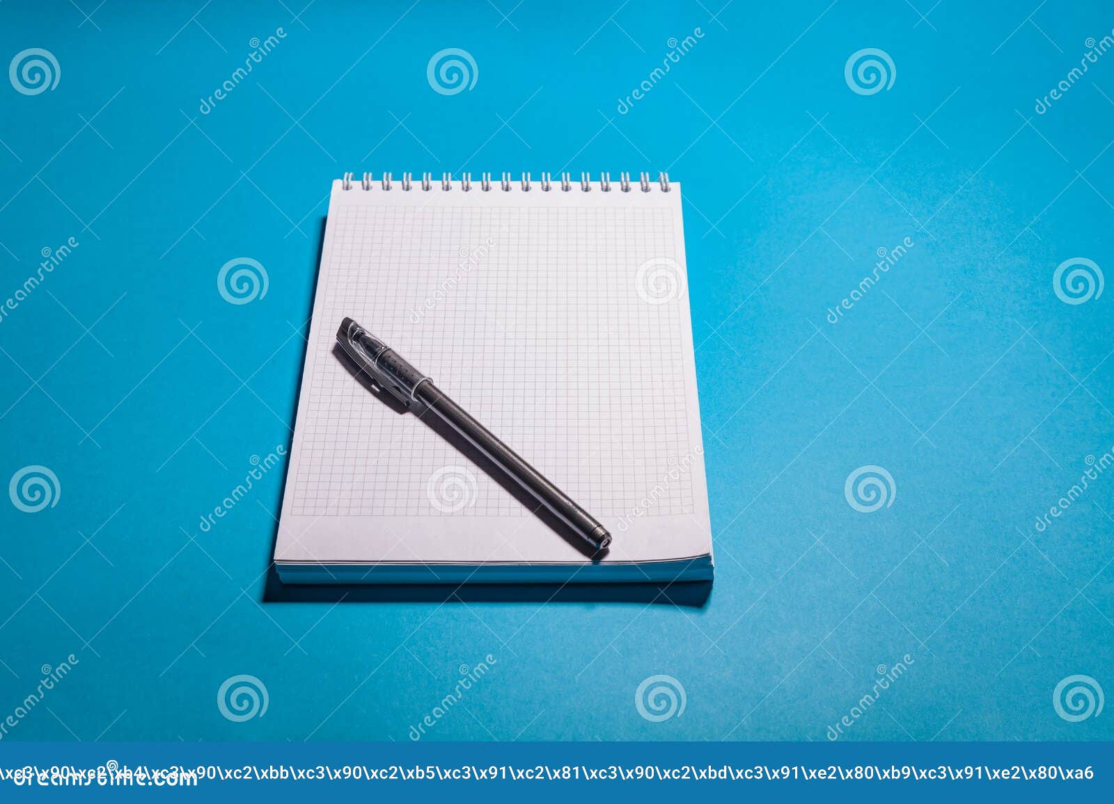 School Notebook in a Cage for Notes with a Ballpoint Pen on a Blue ...