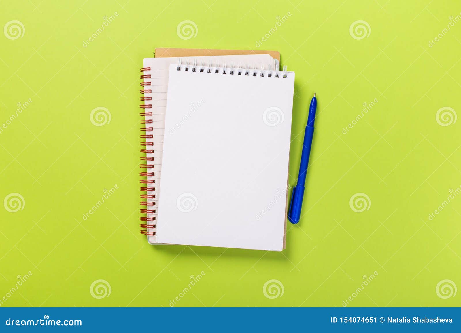 School Notebook On A Green Background, Spiral Notepad On A Table ...