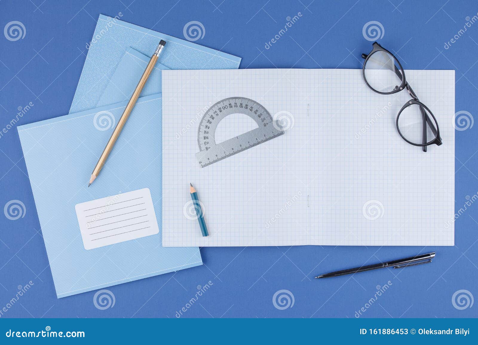 School Notebook with Pen and Glasses on a Blue Table Stock Image ...