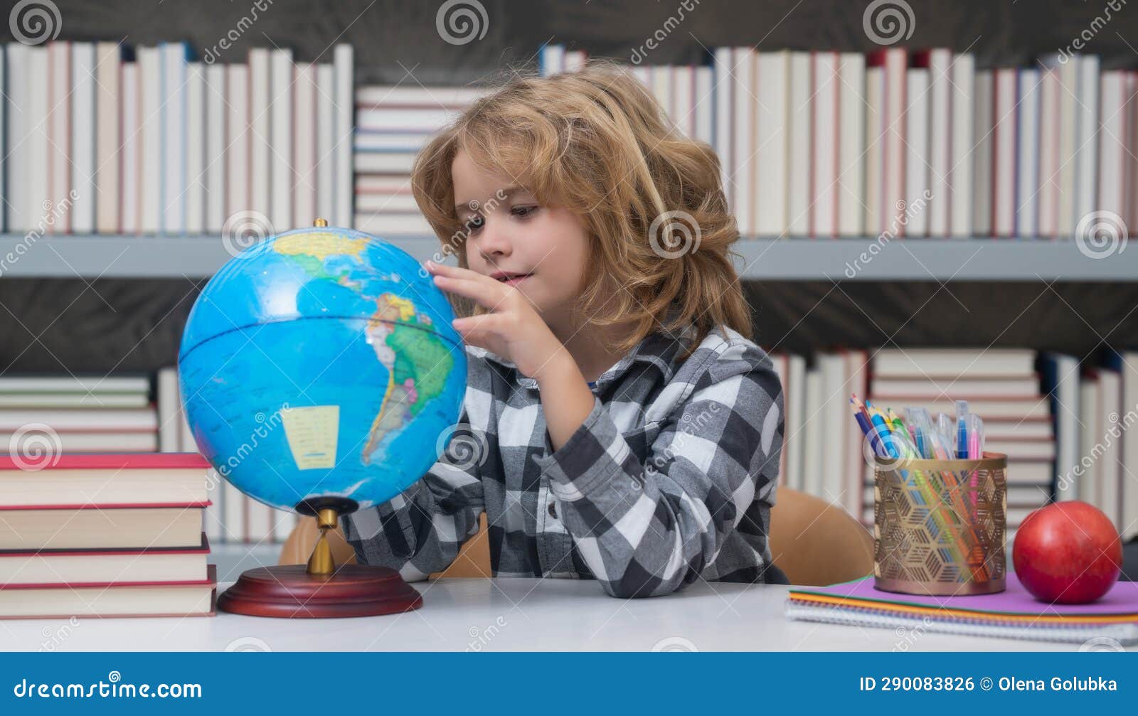 School Pupil Looking at Globe in Library at the Elementary School ...