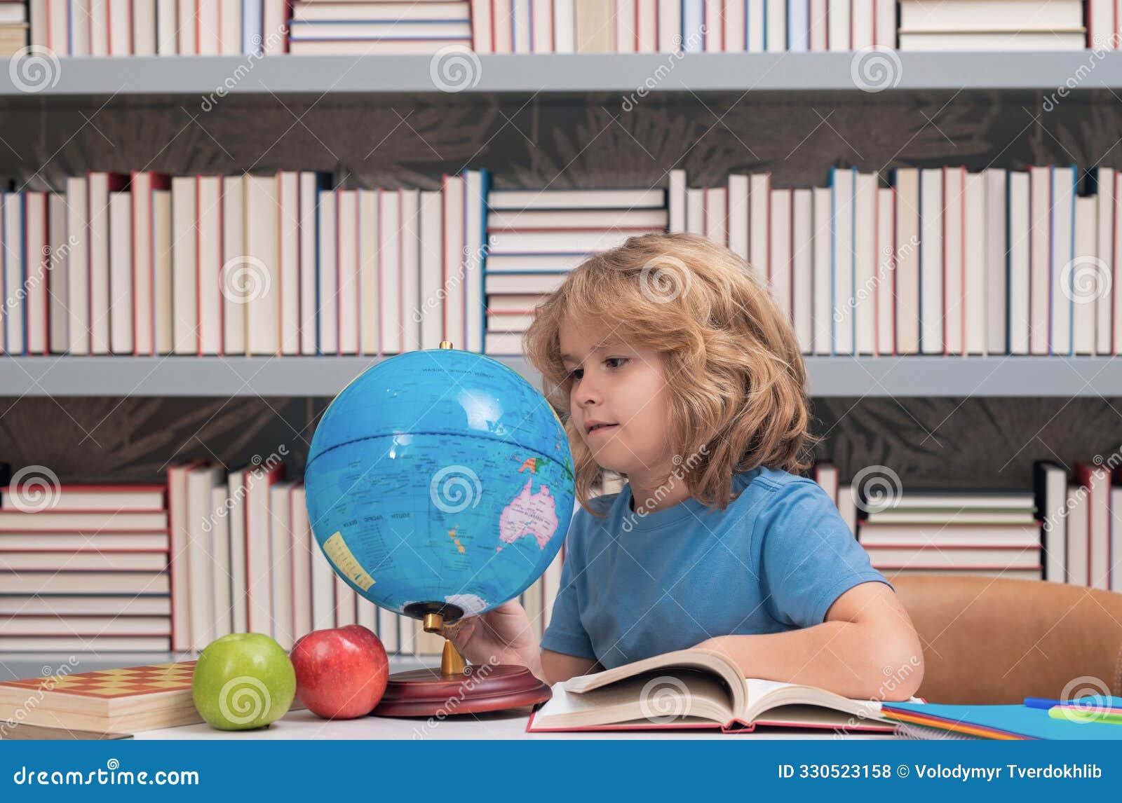 School Pupil Looking at Globe in Library, Geography Lesson. School ...