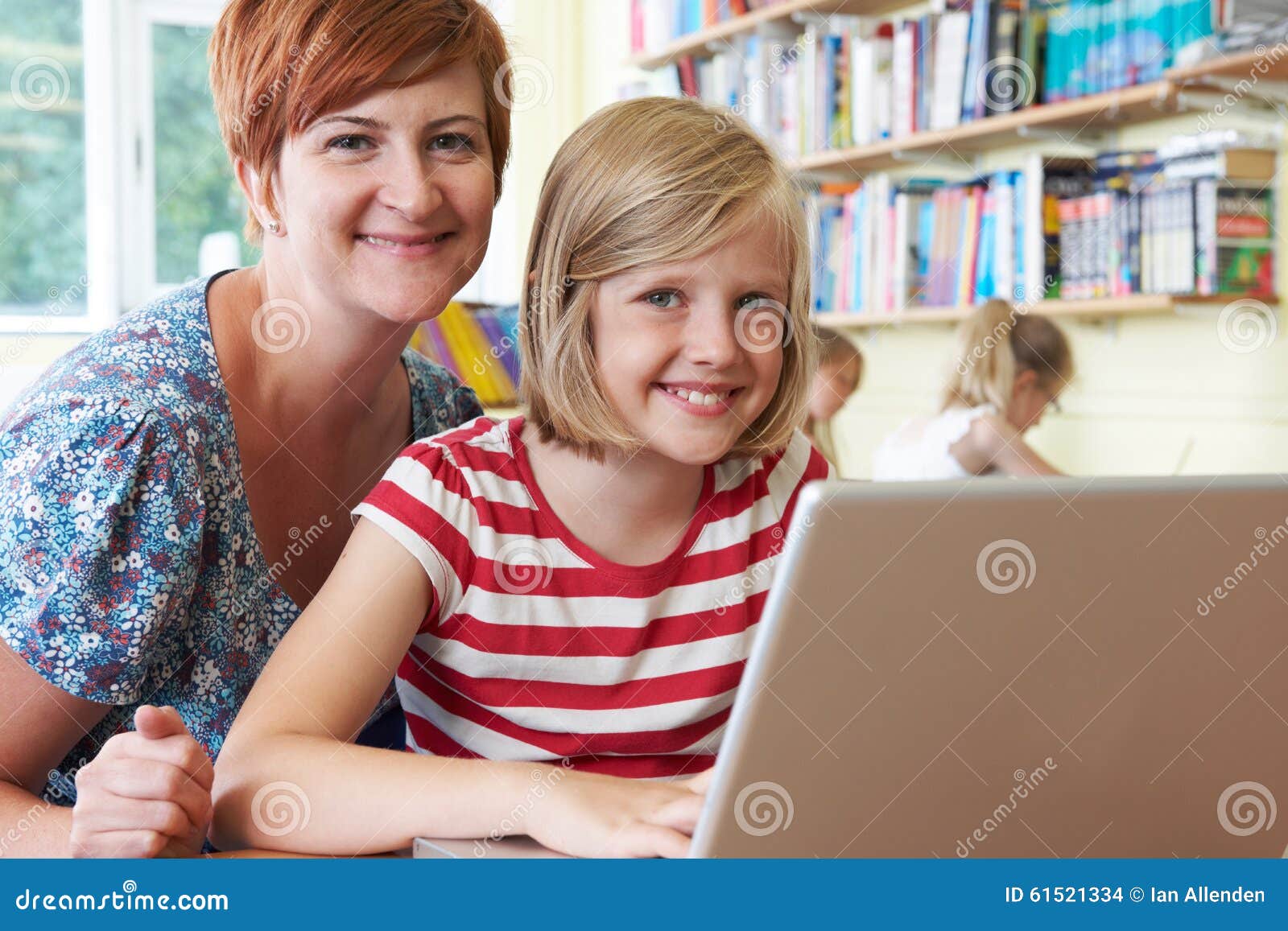 School Pupil with Teacher Using Laptop Computer in Classroom Stock ...
