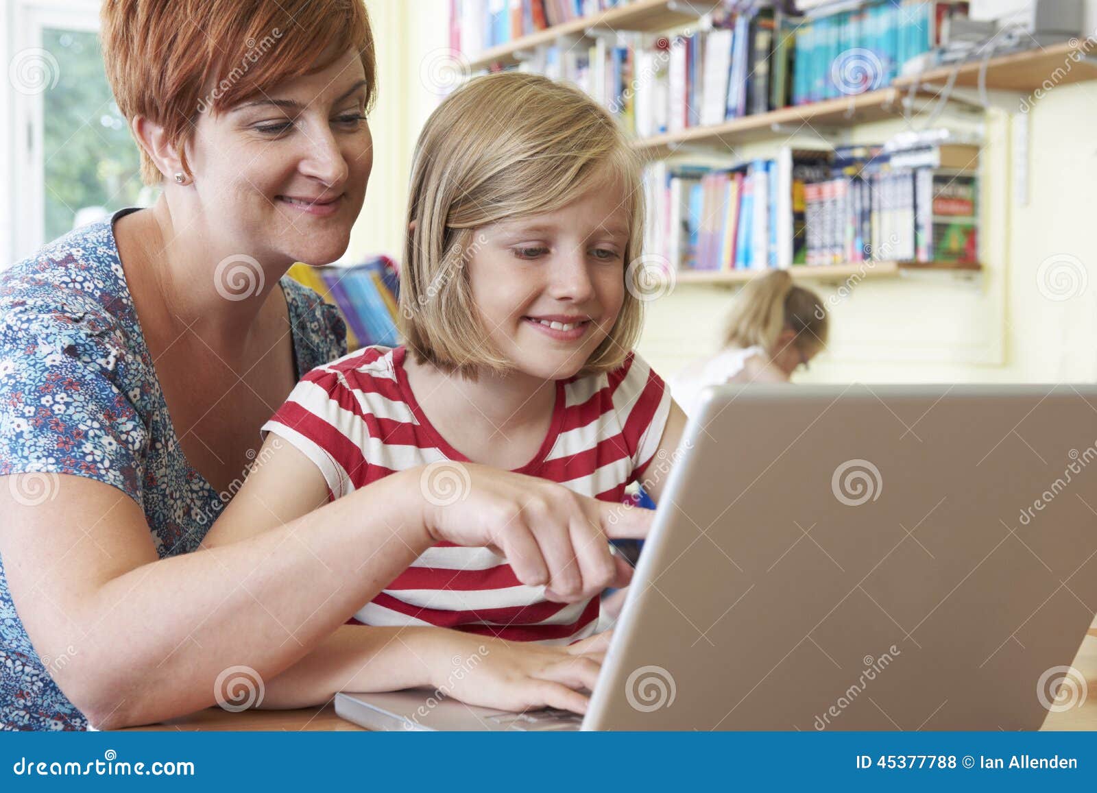 School Pupil with Teacher Using Laptop Computer in Classroom Stock ...
