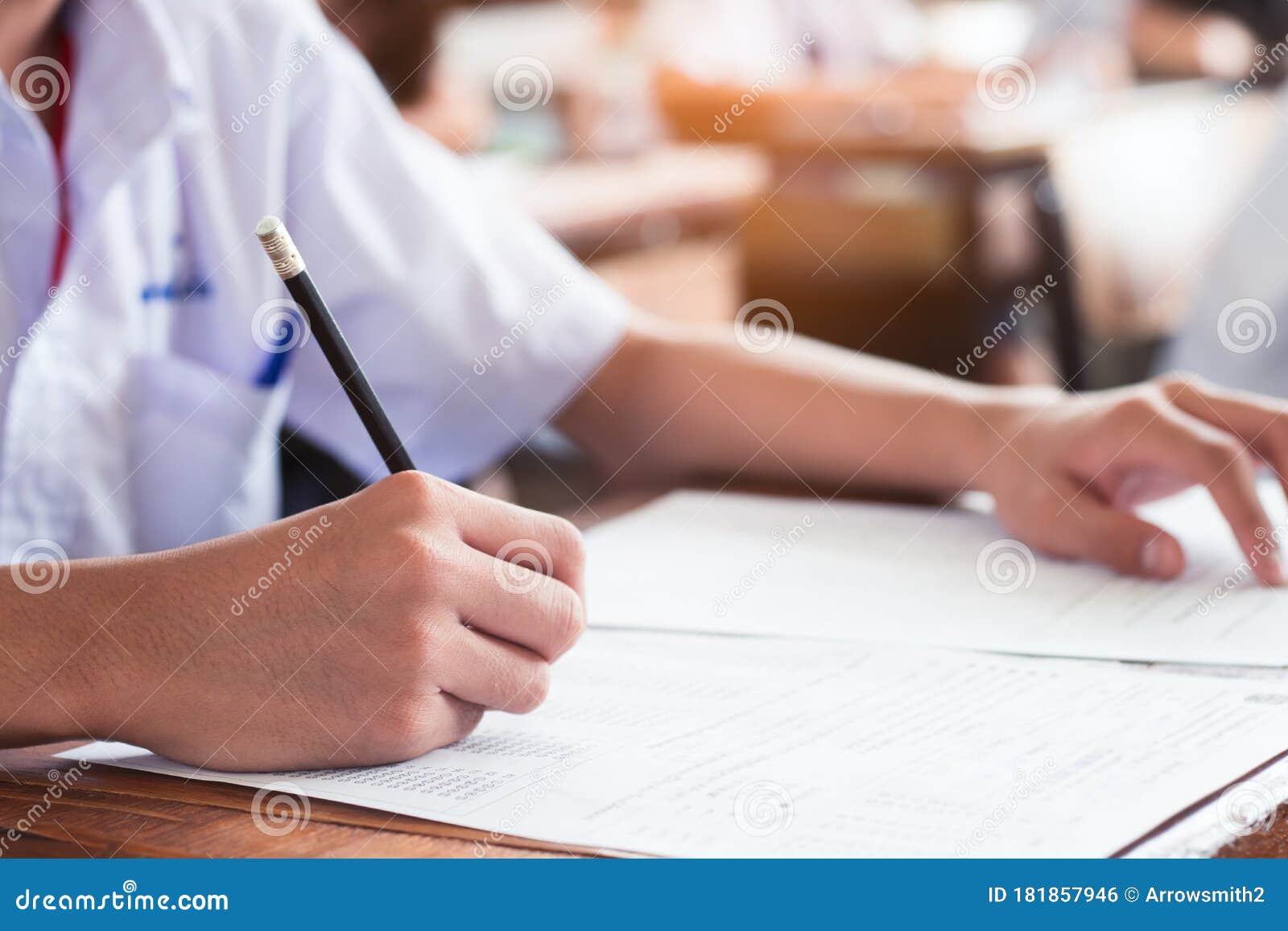 School Student is Taking Exam and Writing Answer in Classroom for ...