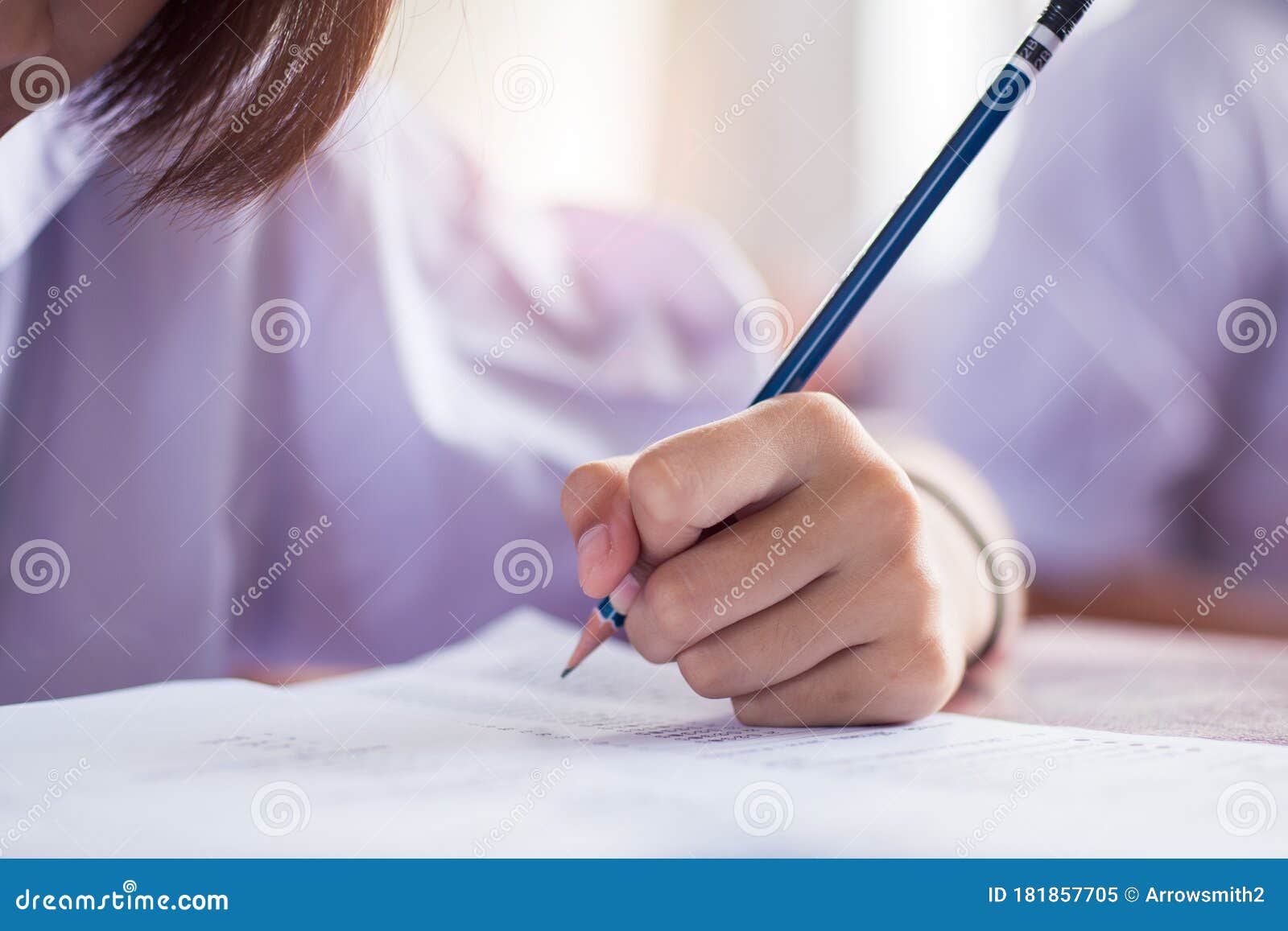 School Student is Taking Exam and Writing Answer in Classroom for ...