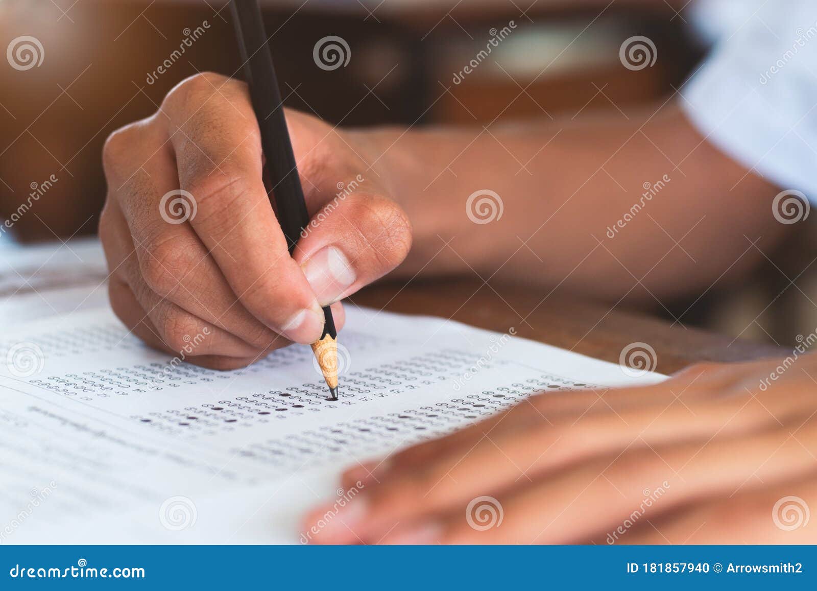 School Student is Taking Exam and Writing Answer in Classroom for ...