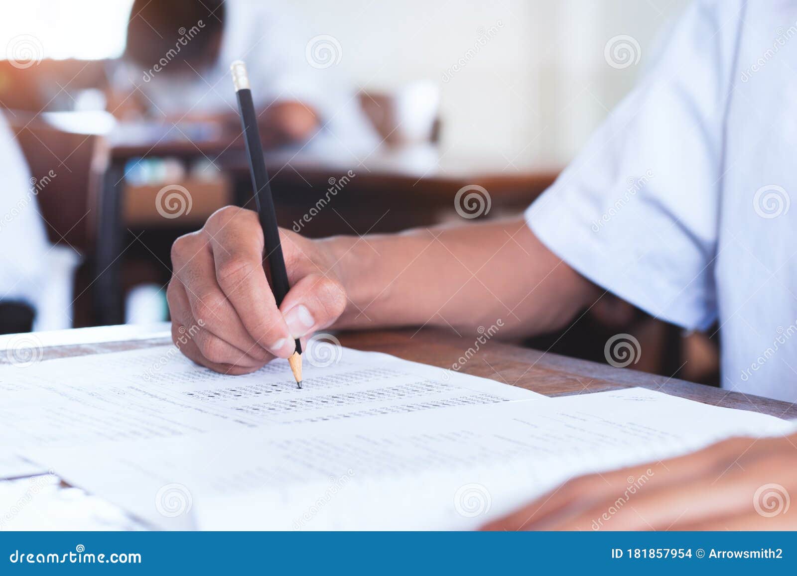 School Student is Taking Exam and Writing Answer in Classroom for ...