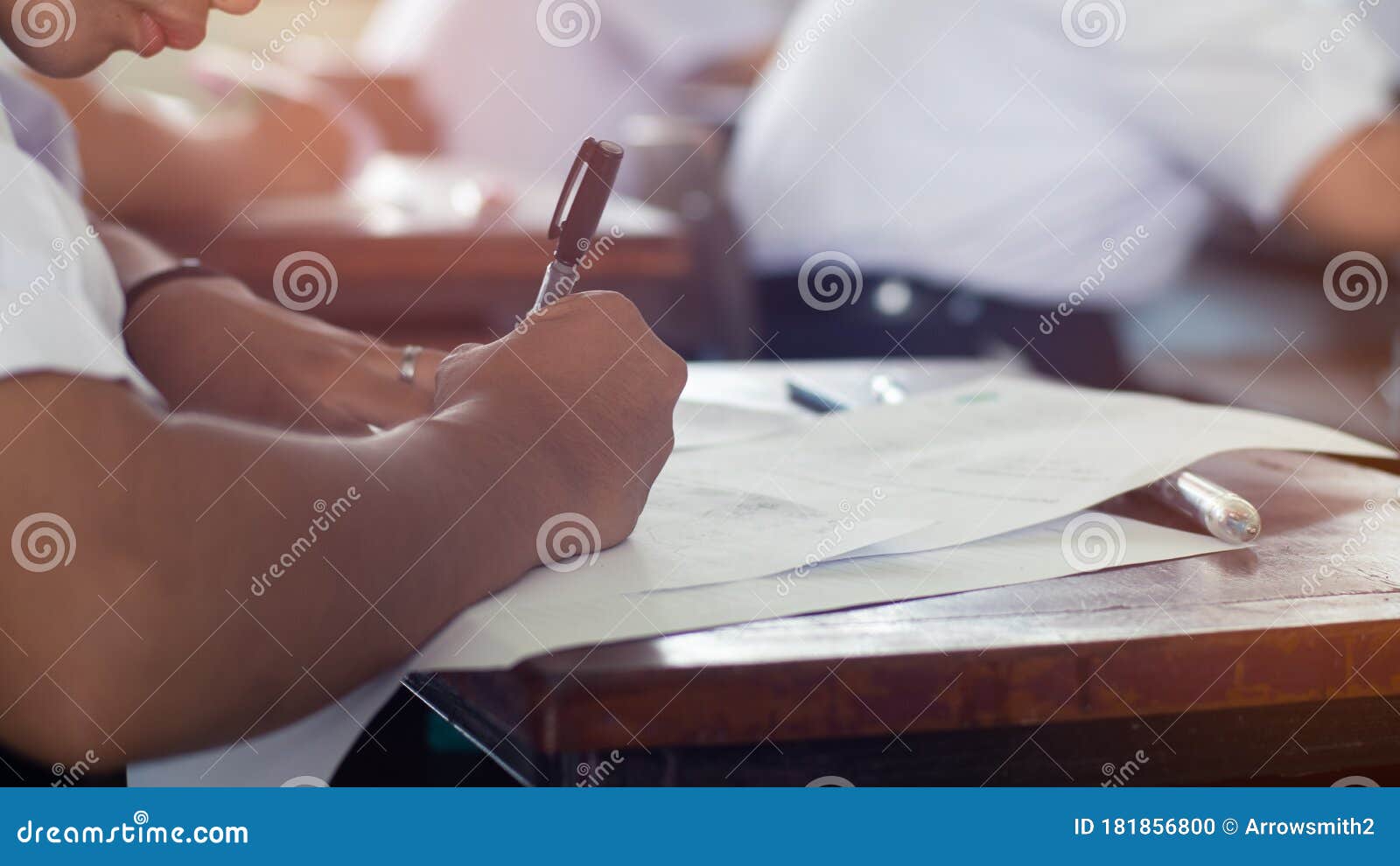 School Student is Taking Exam and Writing Answer in Classroom for ...