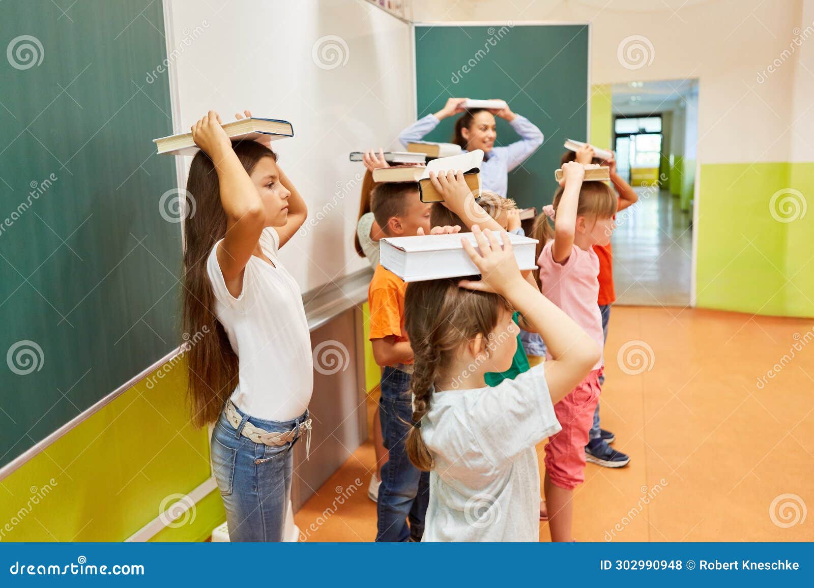 School Students Holding Book Overhead in Class Stock Photo - Image of ...