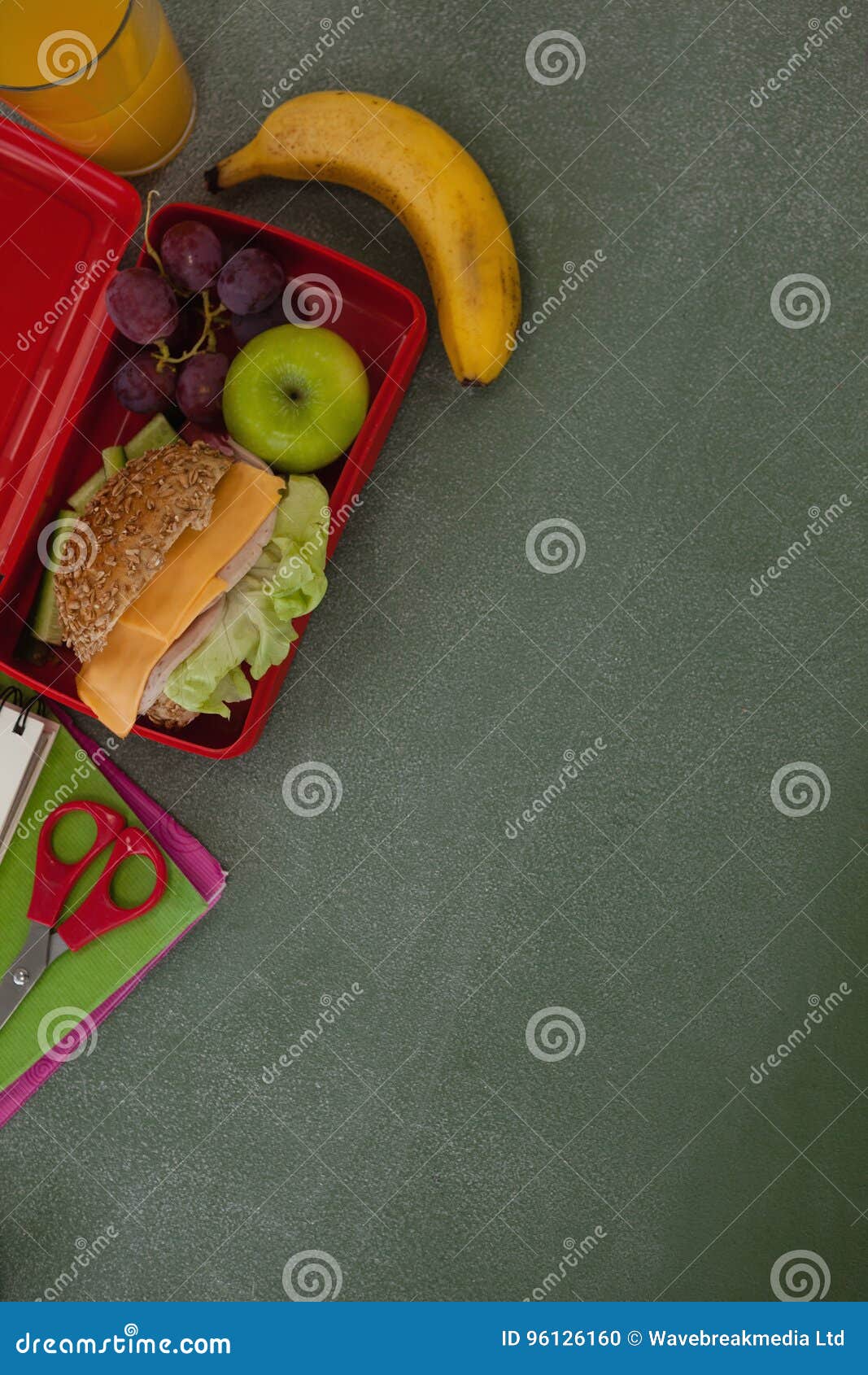 School Supplies and Lunch Box Arranged on Chalkboard Stock Photo ...