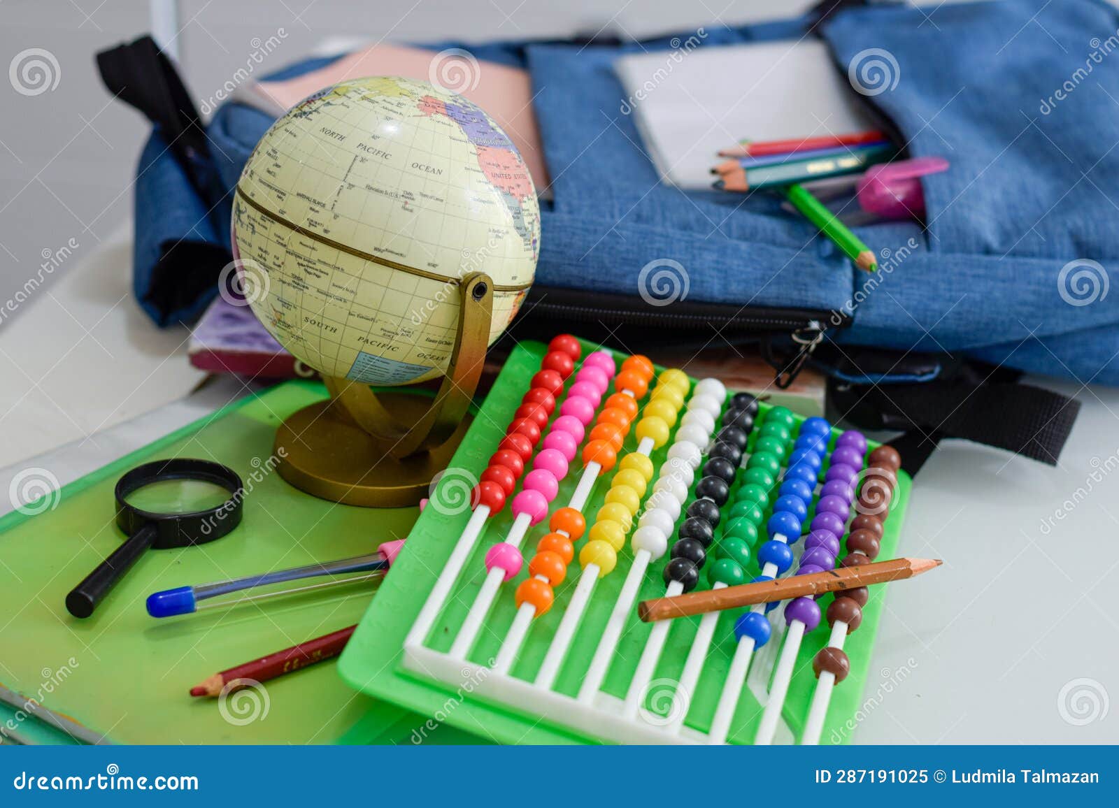 School Supplies on the Study Table, Backpack, Globe, Calculator ...