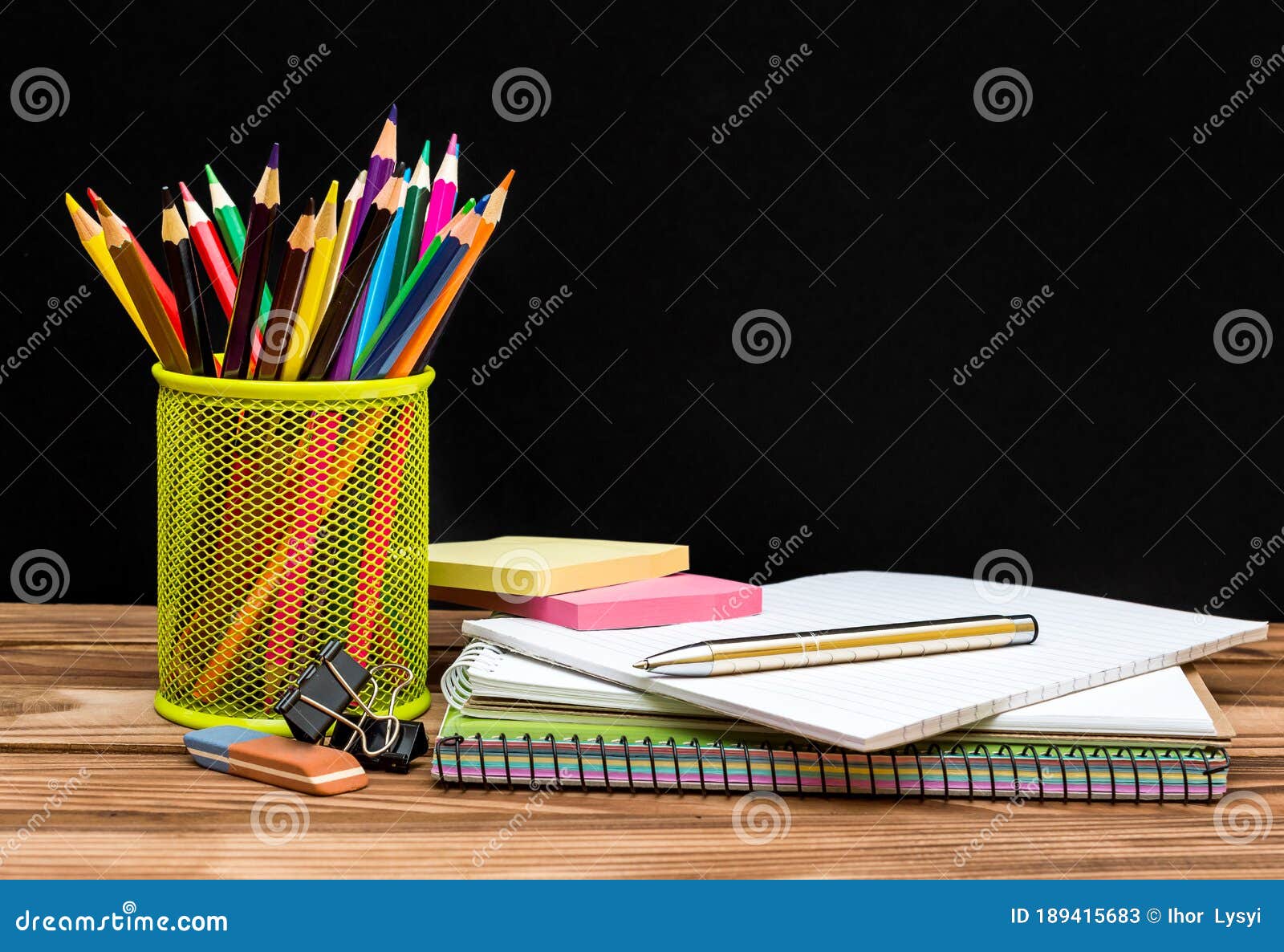 School Supplies on Table Against Blackboard. Education Concept Stock ...