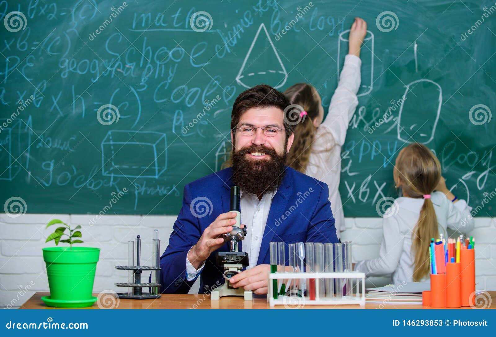 School Teacher of Biology. Man Bearded Teacher Work with Microscope and ...