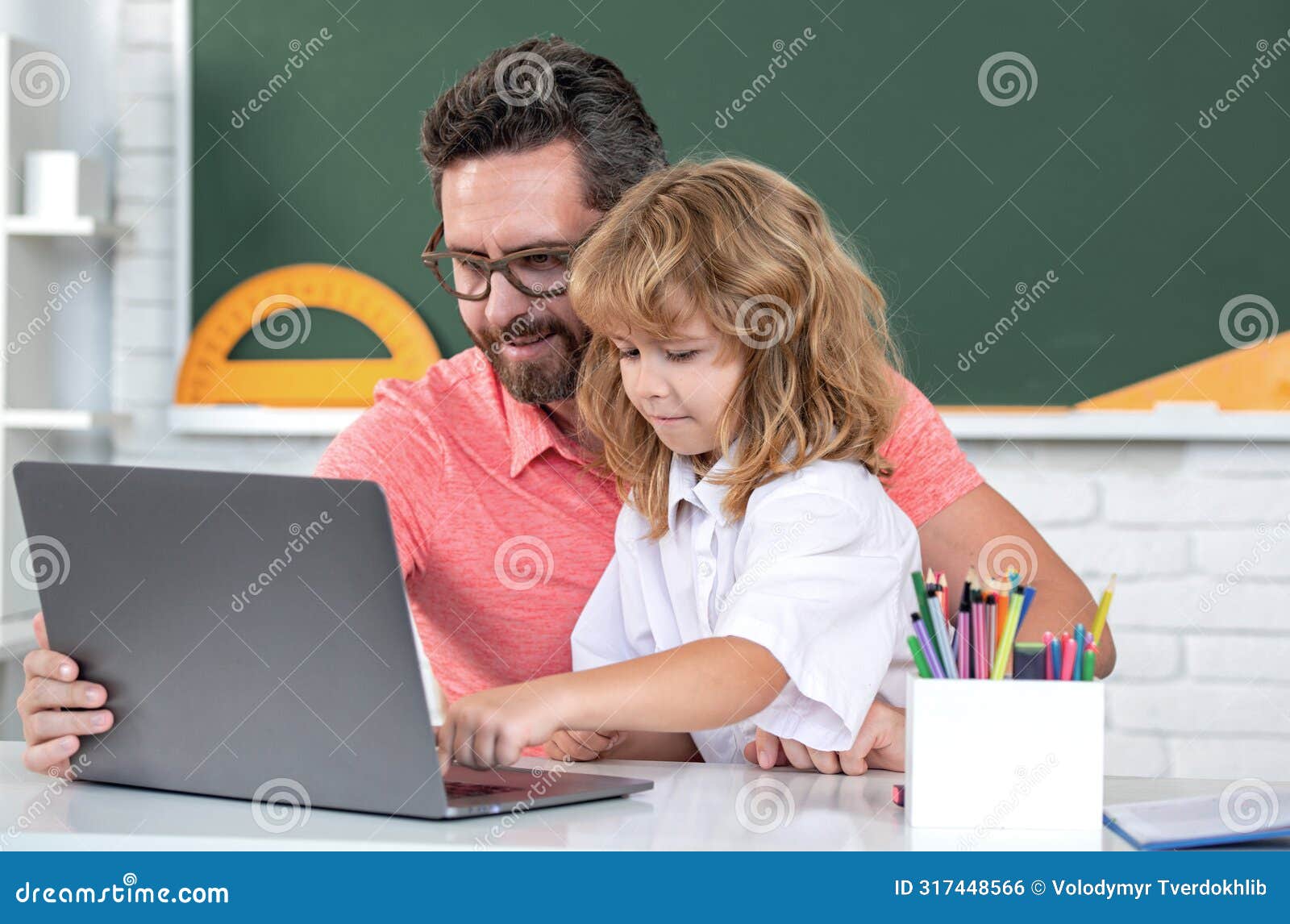 School Teacher and Child Pupil Learning at Laptop Computer, Studying ...