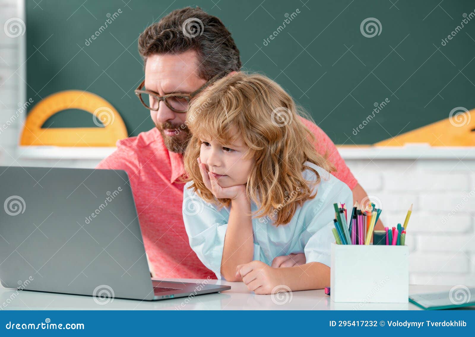 School Teacher with a Schoolboy Learning at Laptop Computer, Studying ...