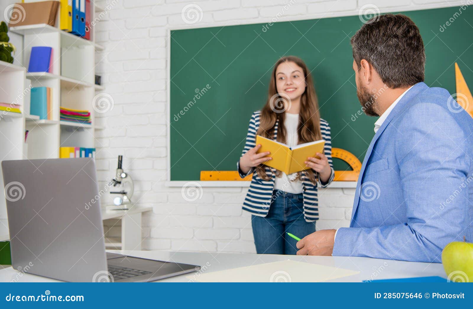 School Teacher with Selective Focus of Cheerful Child at Blackboard ...