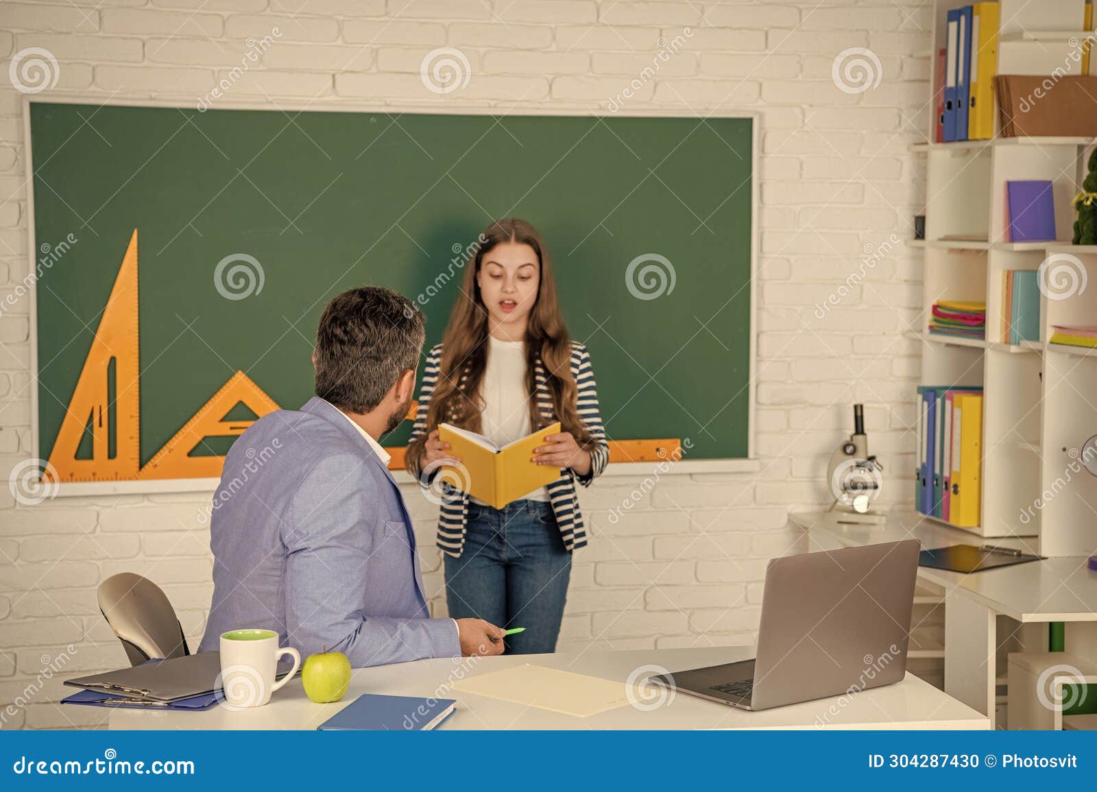 School Teacher with Selective Focus of Child at Blackboard Stock Photo ...