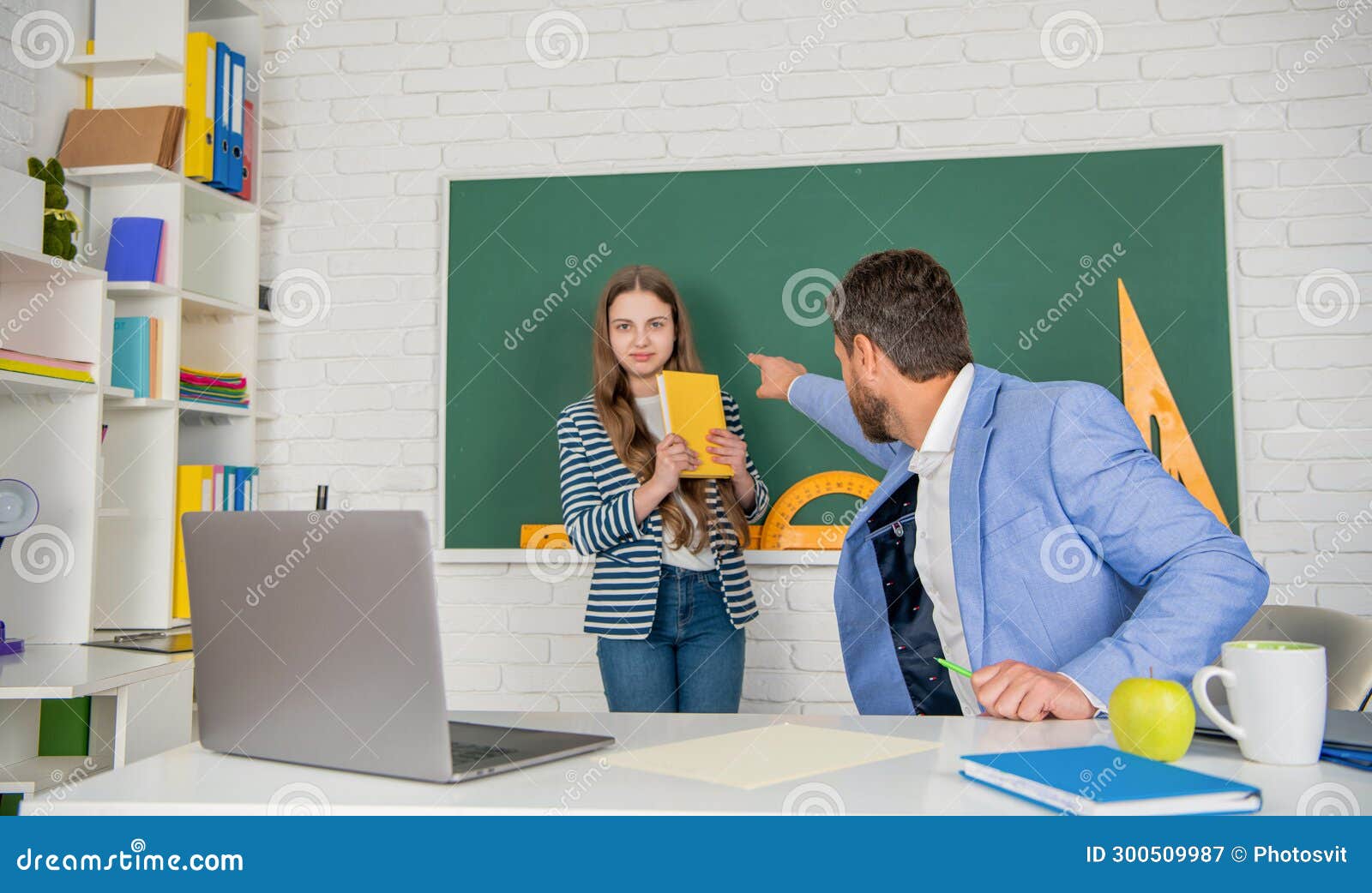 School Teacher with Selective Focus of Child at Blackboard. Pointing ...