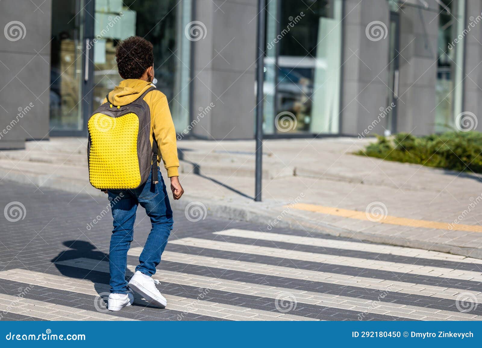 Schoolboy with Backpack on His Back Crossing the Street Stock Photo ...