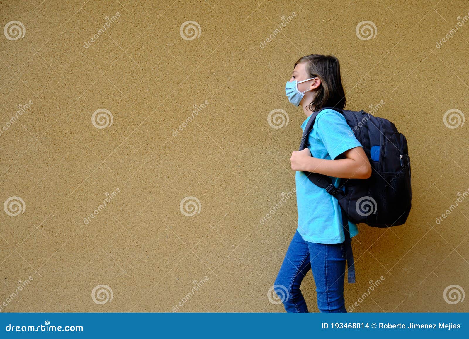Schoolboy with a Backpack Walking To School and Wearing a Protective ...