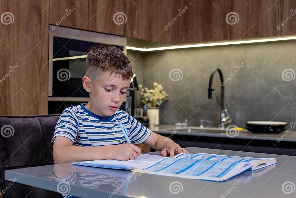 Schoolboy Boy Writes Lessons in the Kitchen Stock Photo - Image of ...