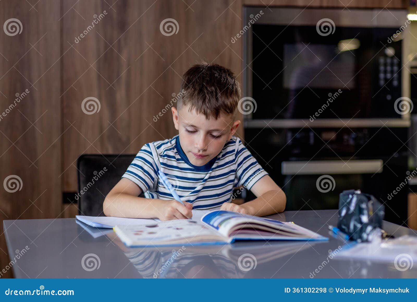 Schoolboy Boy Writes Lessons in the Kitchen Stock Photo - Image of ...