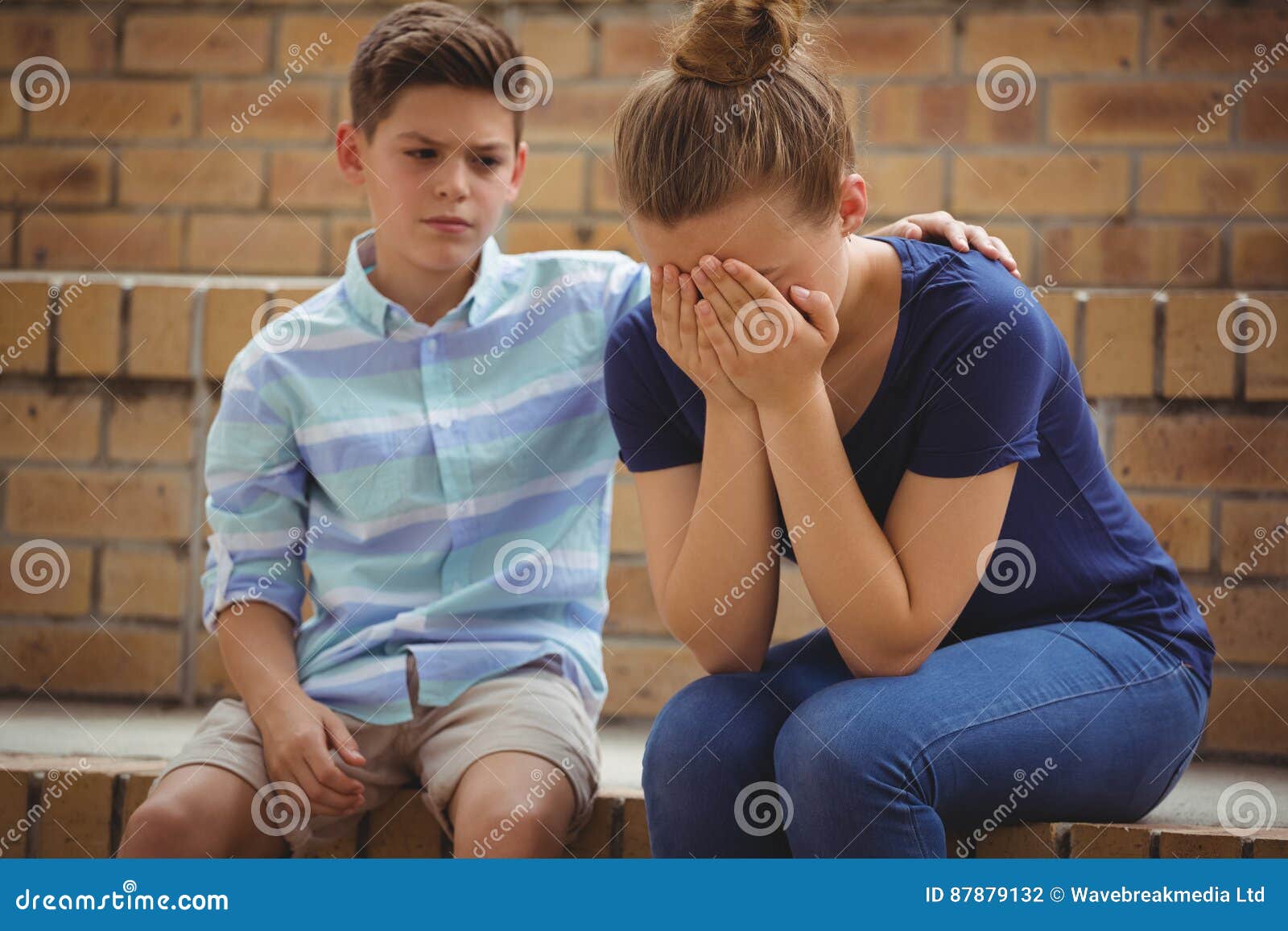 Schoolboy Consoling Her Sad Friend on Steps in Campus Stock Photo ...