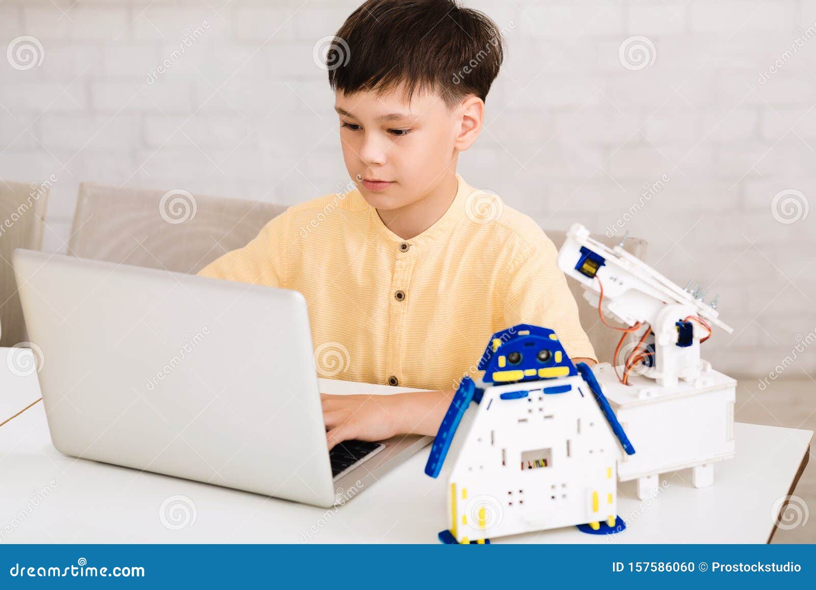 Schoolboy Constructing Robotic Toys and Using Laptop Stock Photo ...