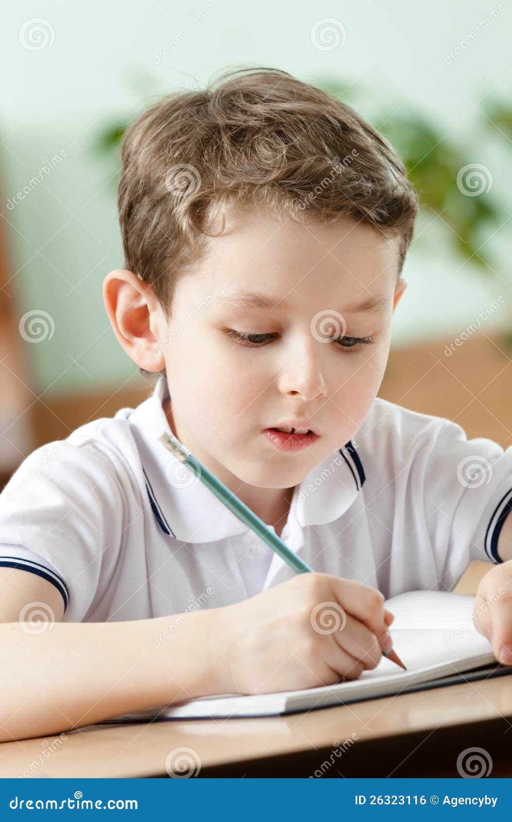 Schoolboy does some notes stock photo. Image of color - 26323116
