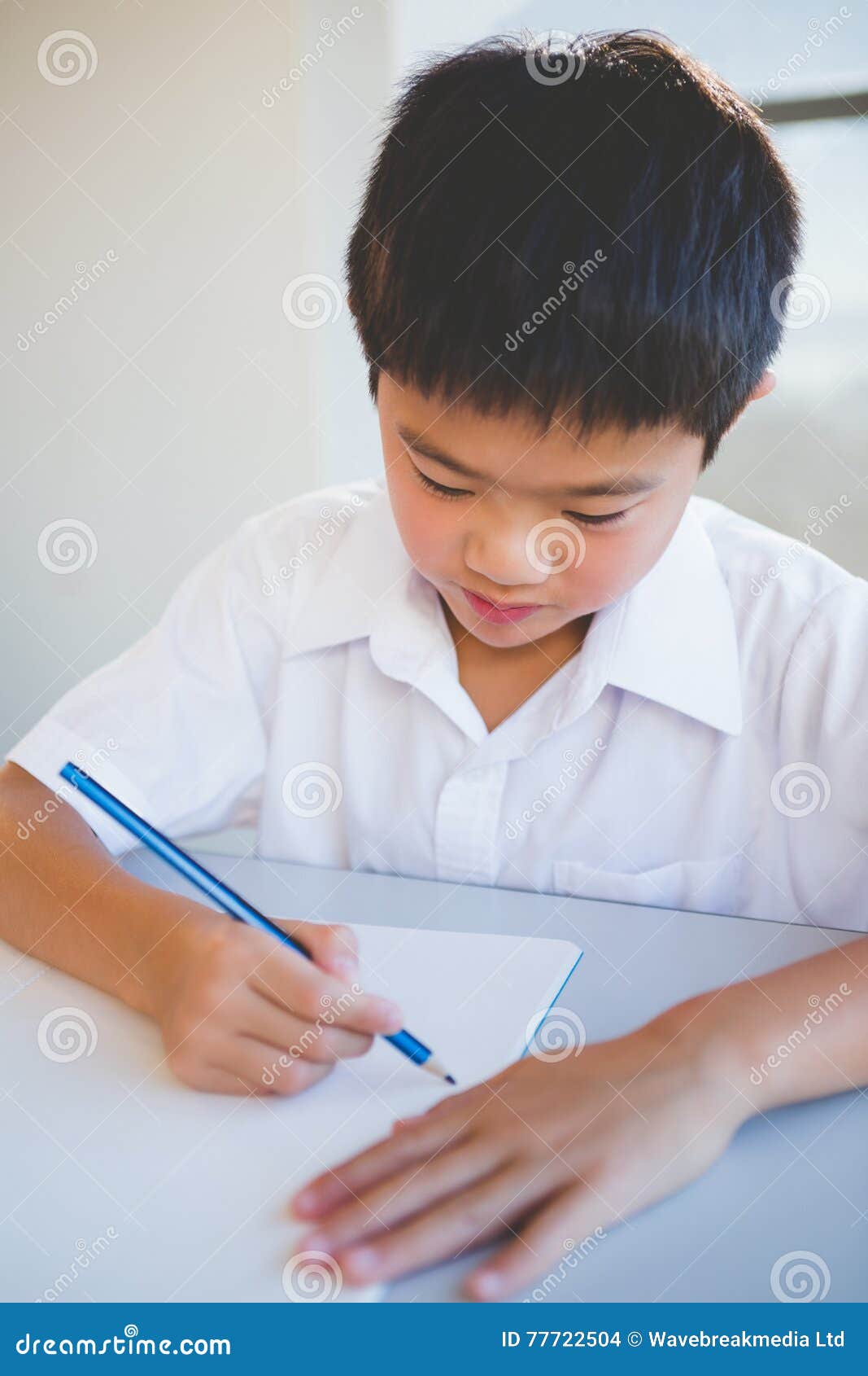 Schoolboy Doing Homework in Classroom Stock Photo - Image of learn ...