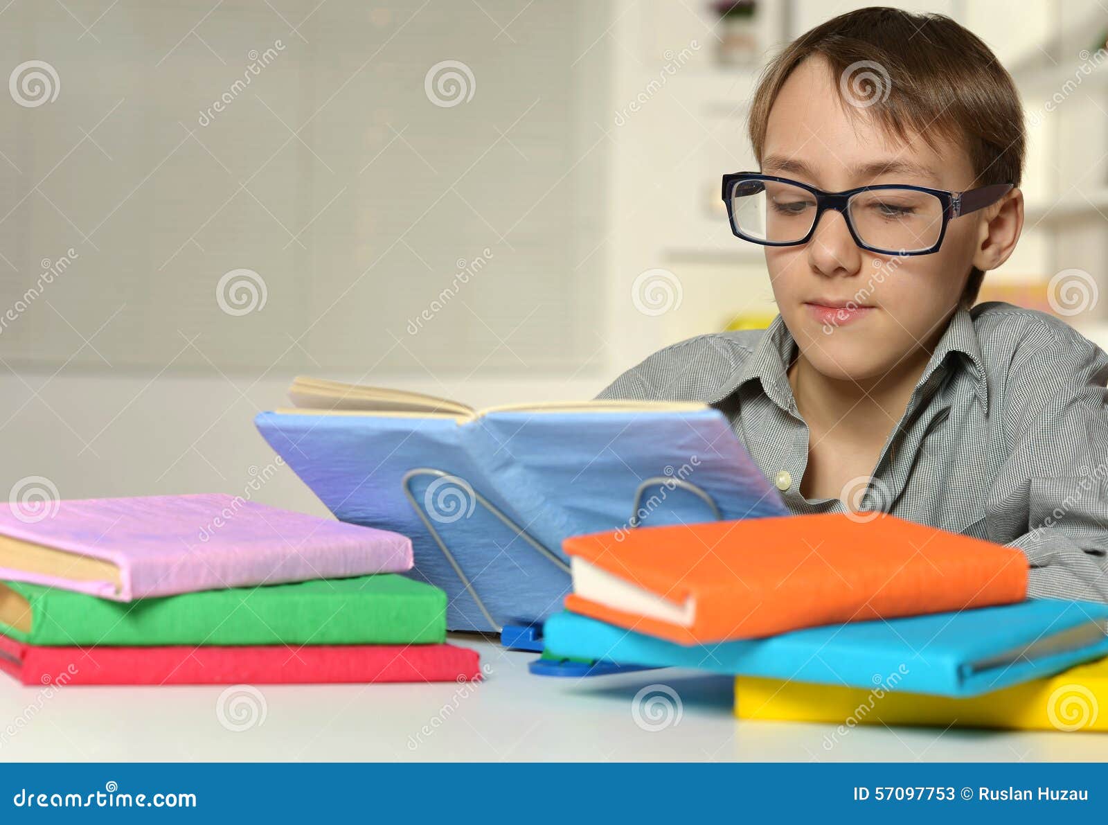 Schoolboy doing homework stock image. Image of lying - 57097753