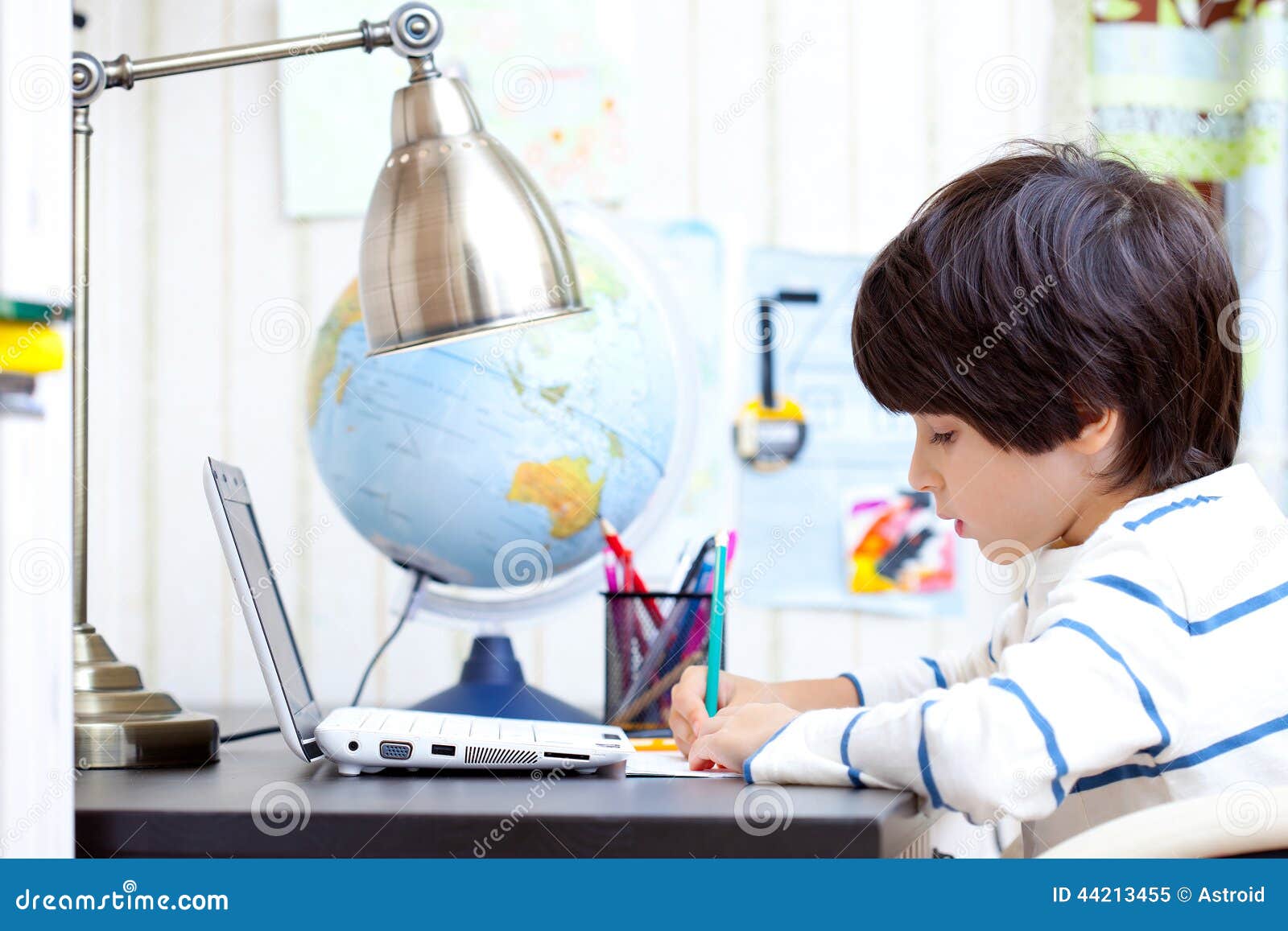Schoolboy doing homework stock image. Image of program - 44213455