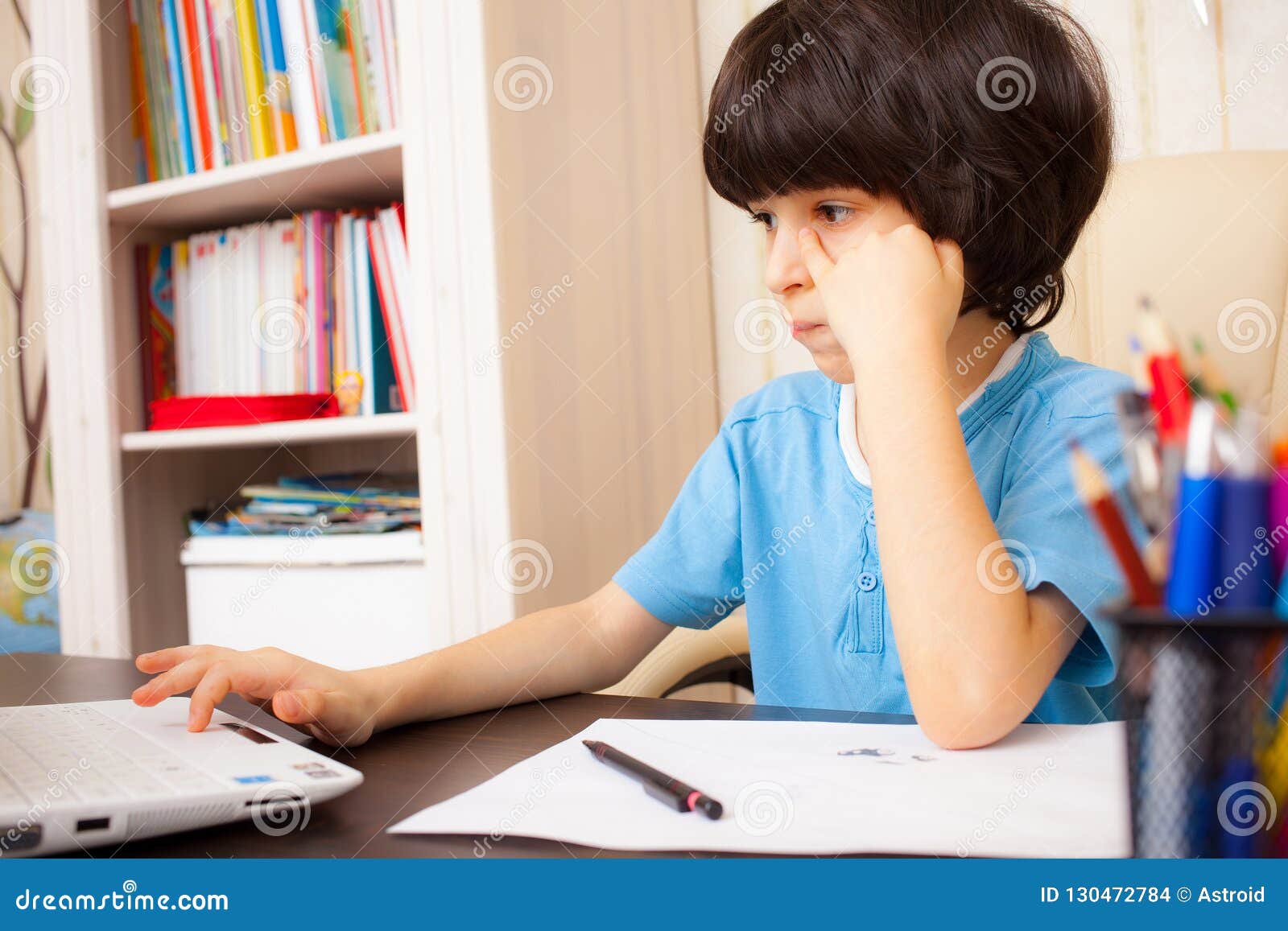 Schoolboy doing homework stock photo. Image of learning - 130472784