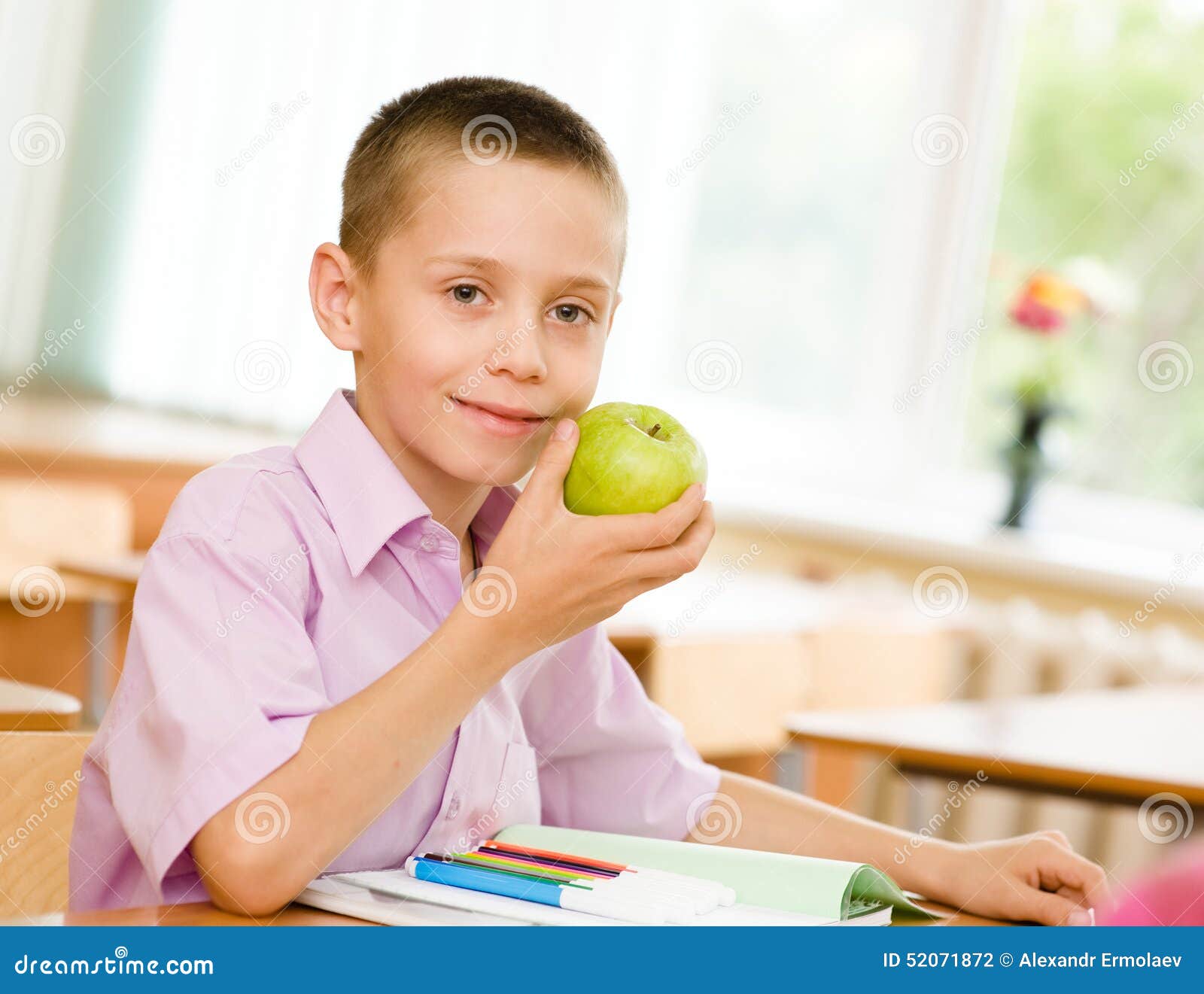 Schoolboy eating an apple stock photo. Image of looking - 52071872