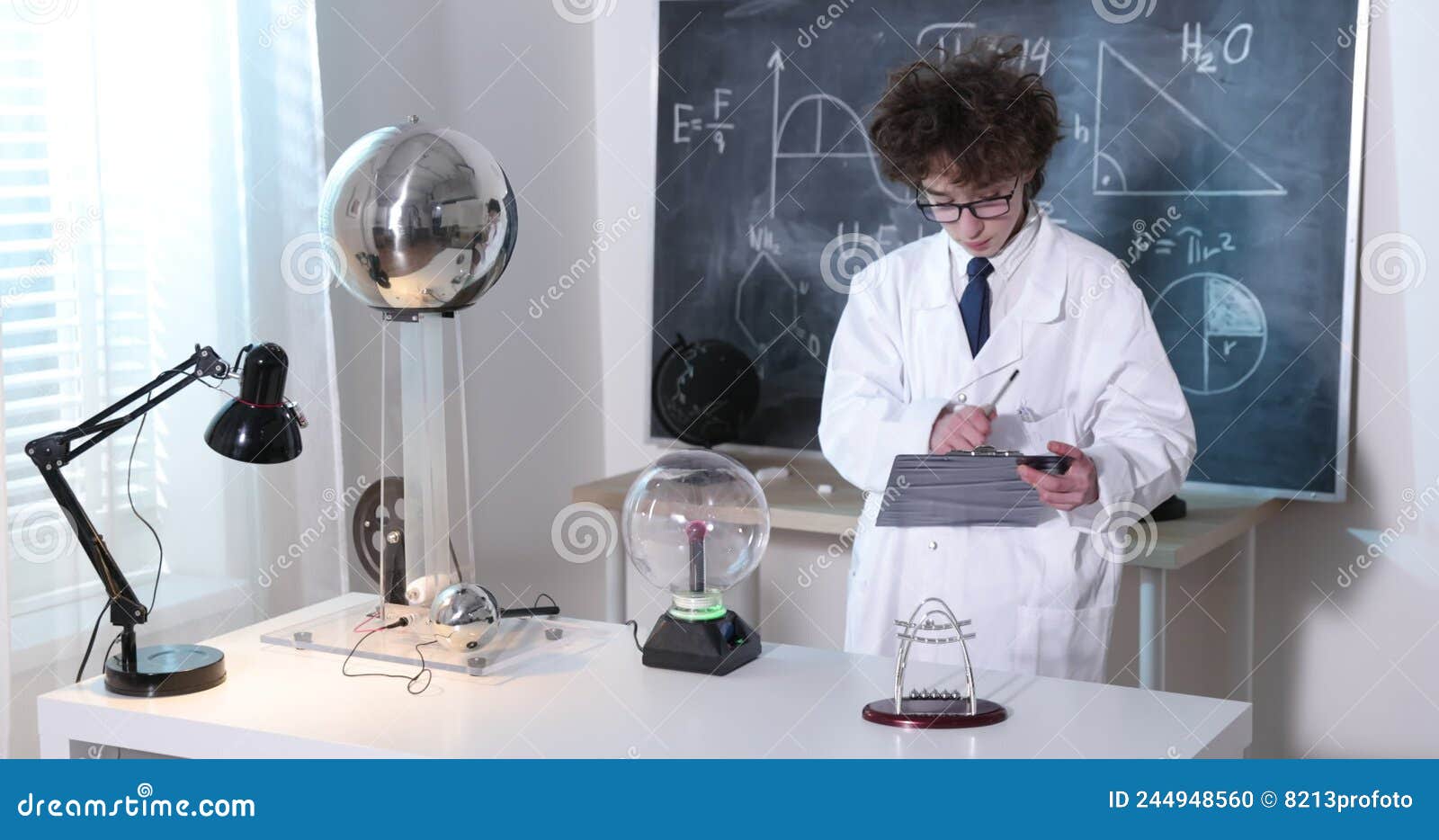 Schoolboy Experimenting in Physics Class. Young Student Doing Physics ...