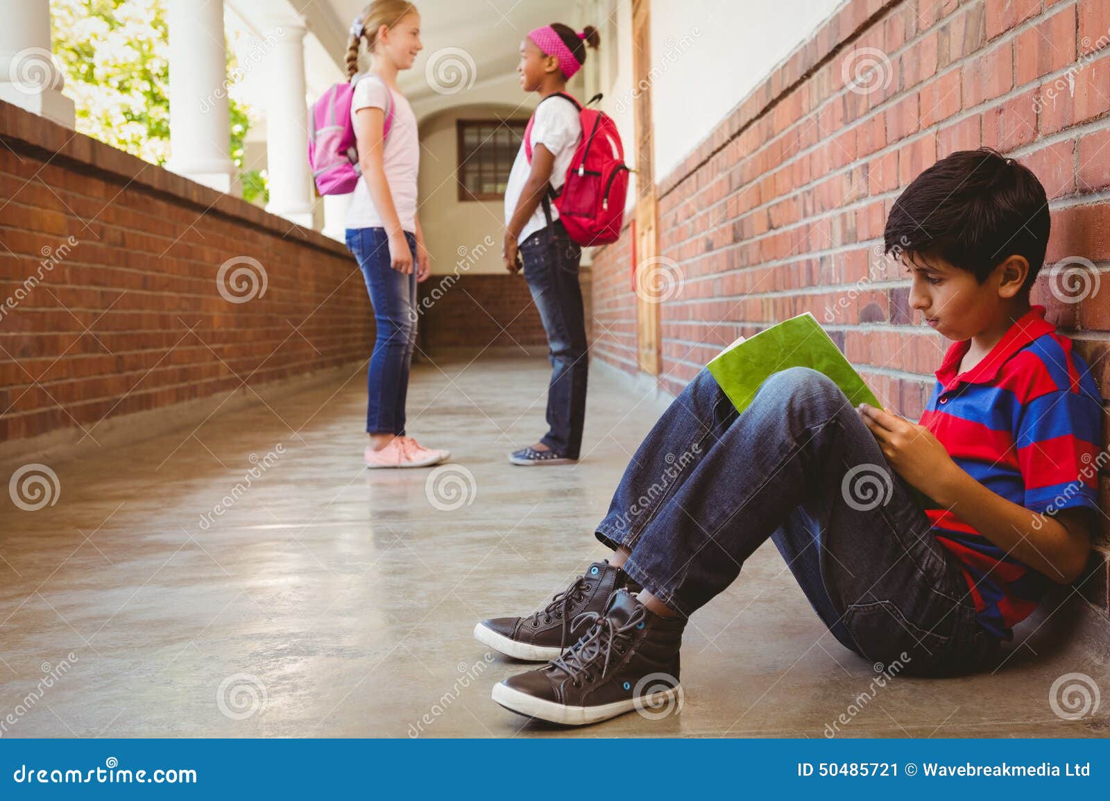 Schoolboy with Friends in Background at School Corridor Stock Image ...