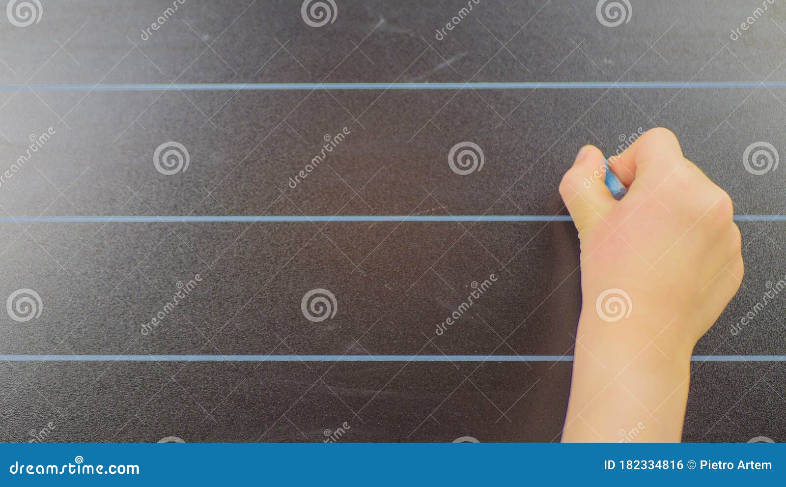Schoolboy Hand Writes in Chalk on a Blackboard during a Lesson at Schoo ...
