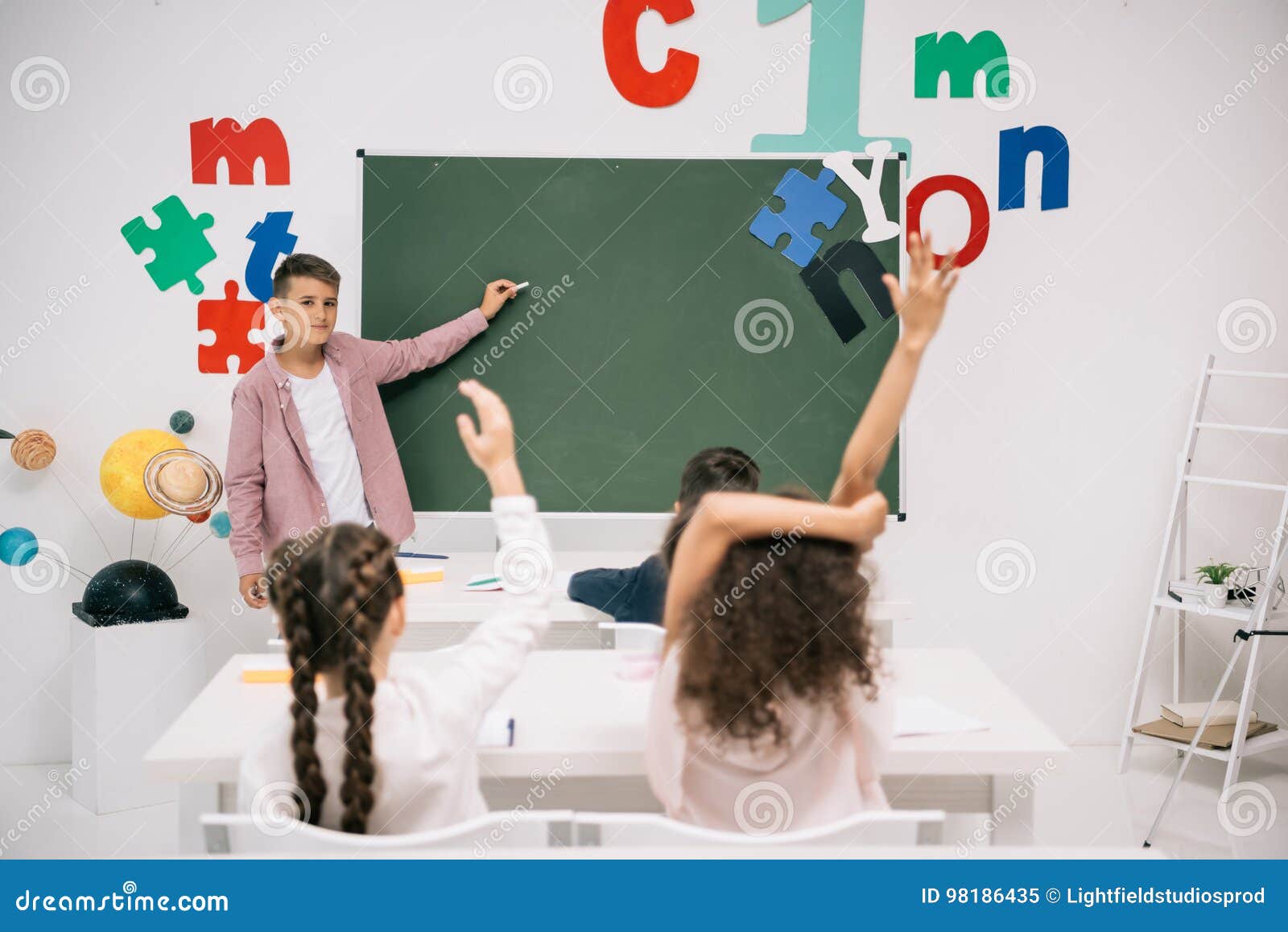 Schoolboy Holding Chalk and Pointing at Blackboard Stock Image - Image ...