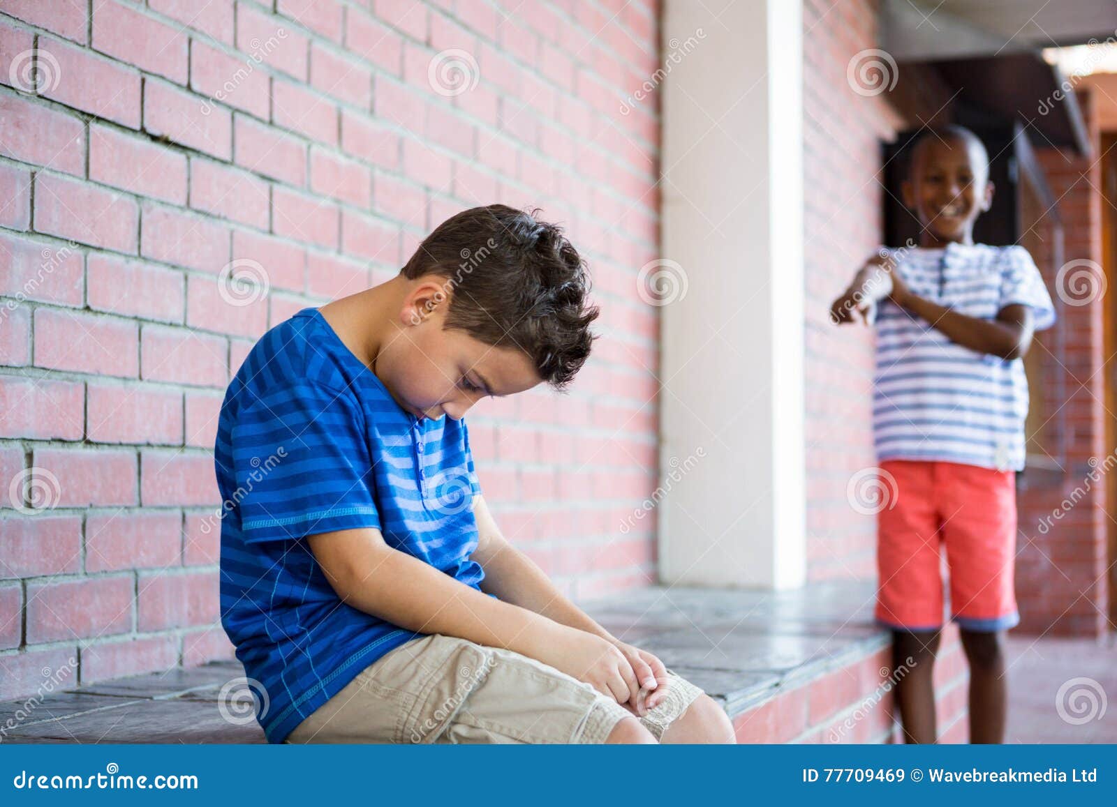 Schoolboy Laughing on Sad Classmate in Corridor Stock Image - Image of ...