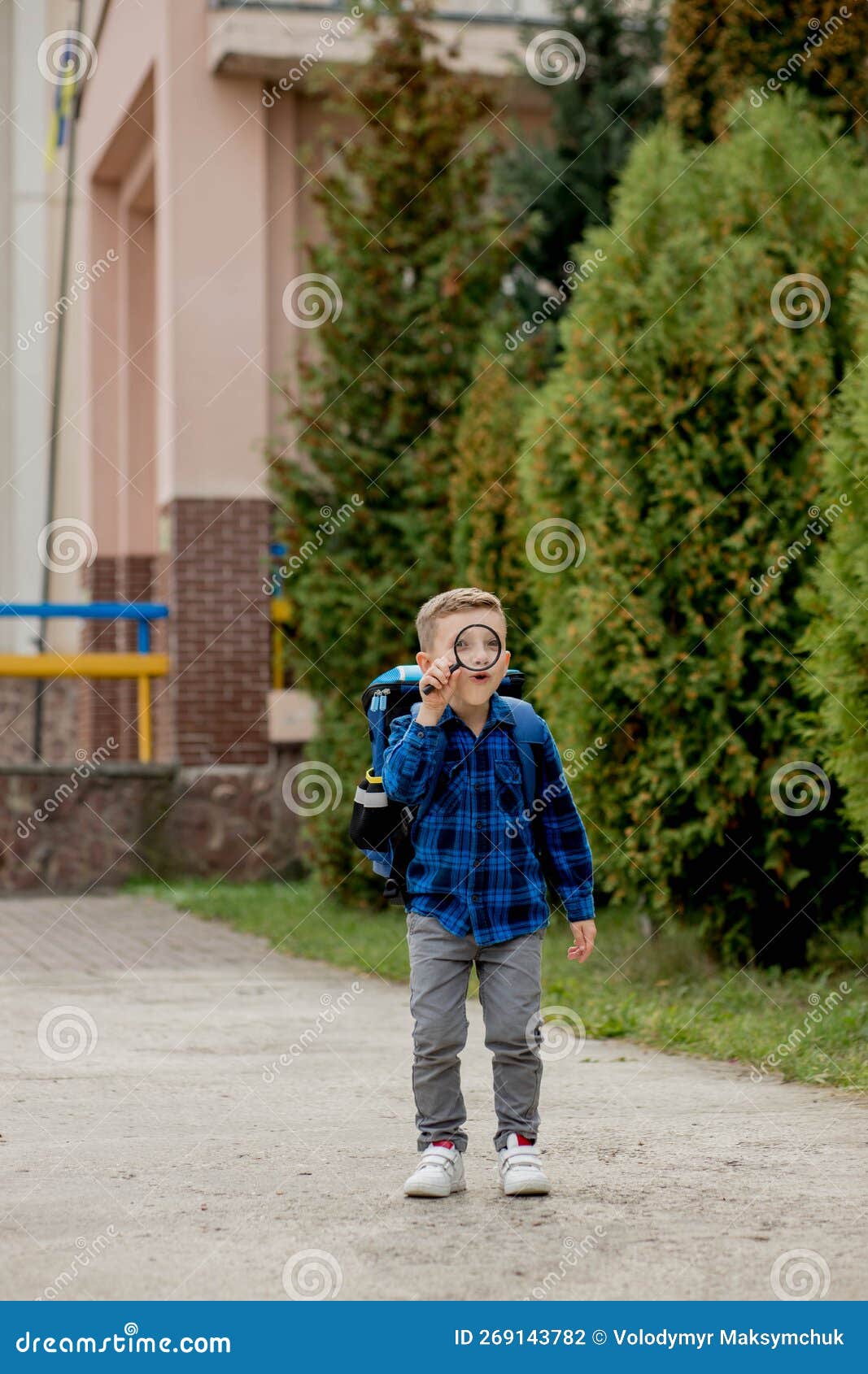 Schoolboy Looking through a Magnifying Glass, with a Surprised ...