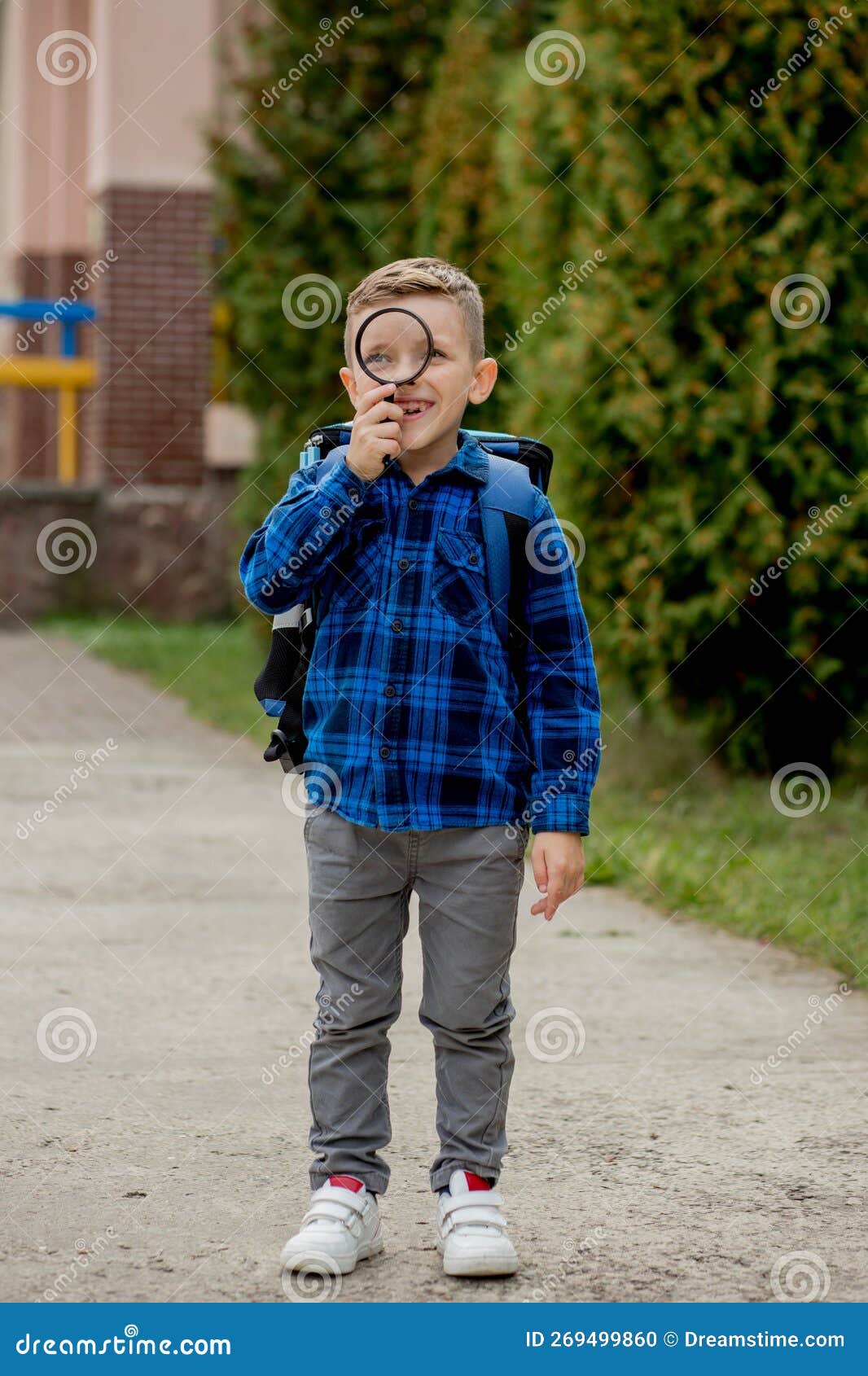 Schoolboy Looking through a Magnifying Glass, with a Surprised ...