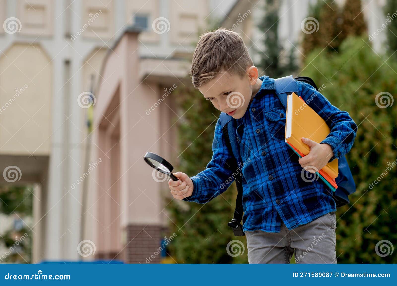 Schoolboy Looking through a Magnifying Glass, with a Surprised ...