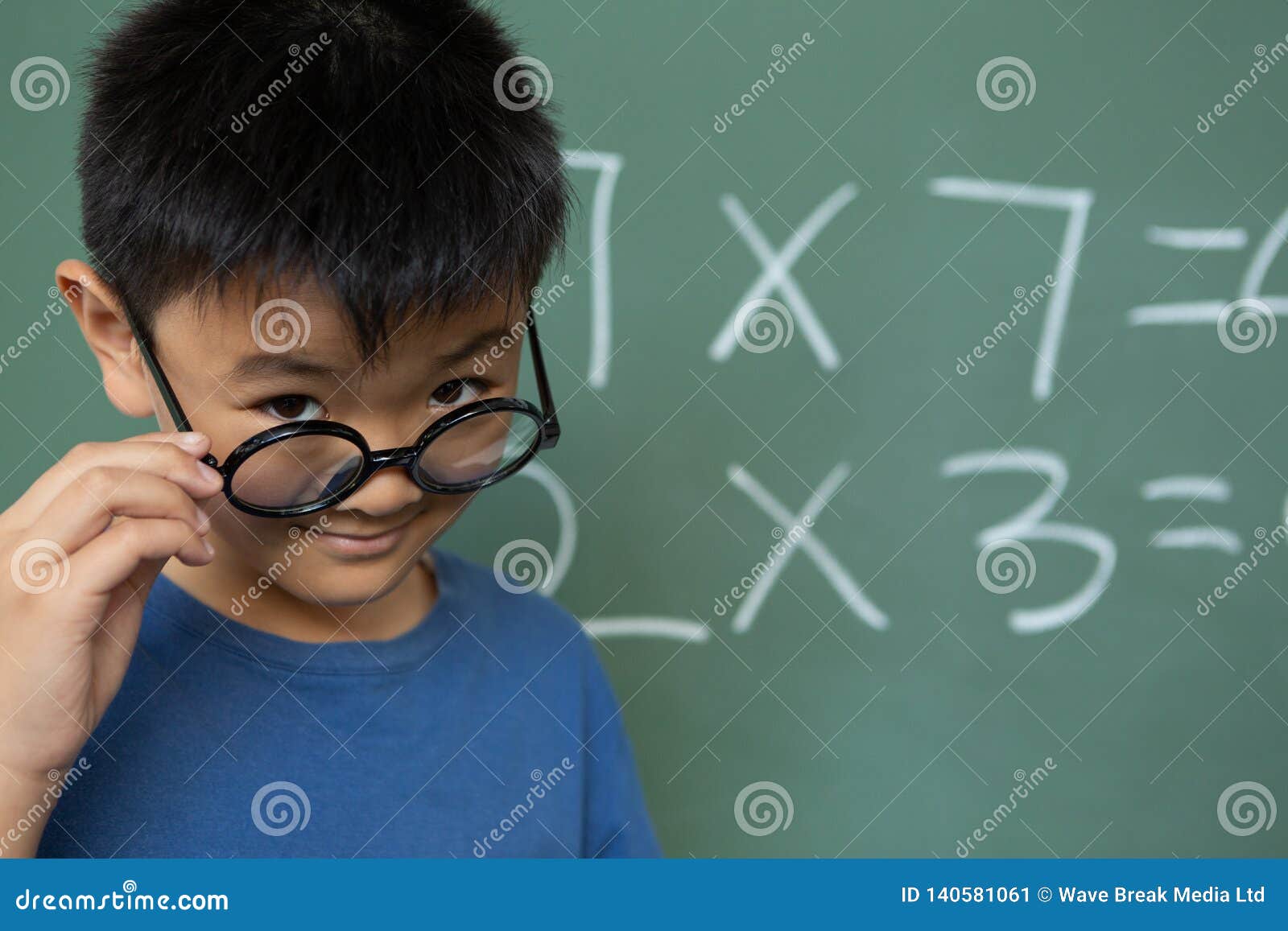 Schoolboy Looking Over Spectacle in a Classroom Stock Image - Image of ...
